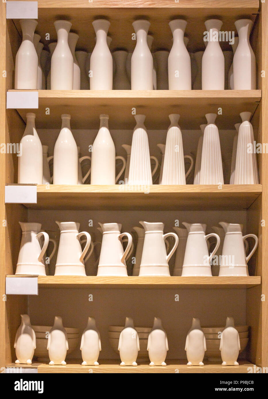 Various containers on the shelves in the shop window. All things are ...