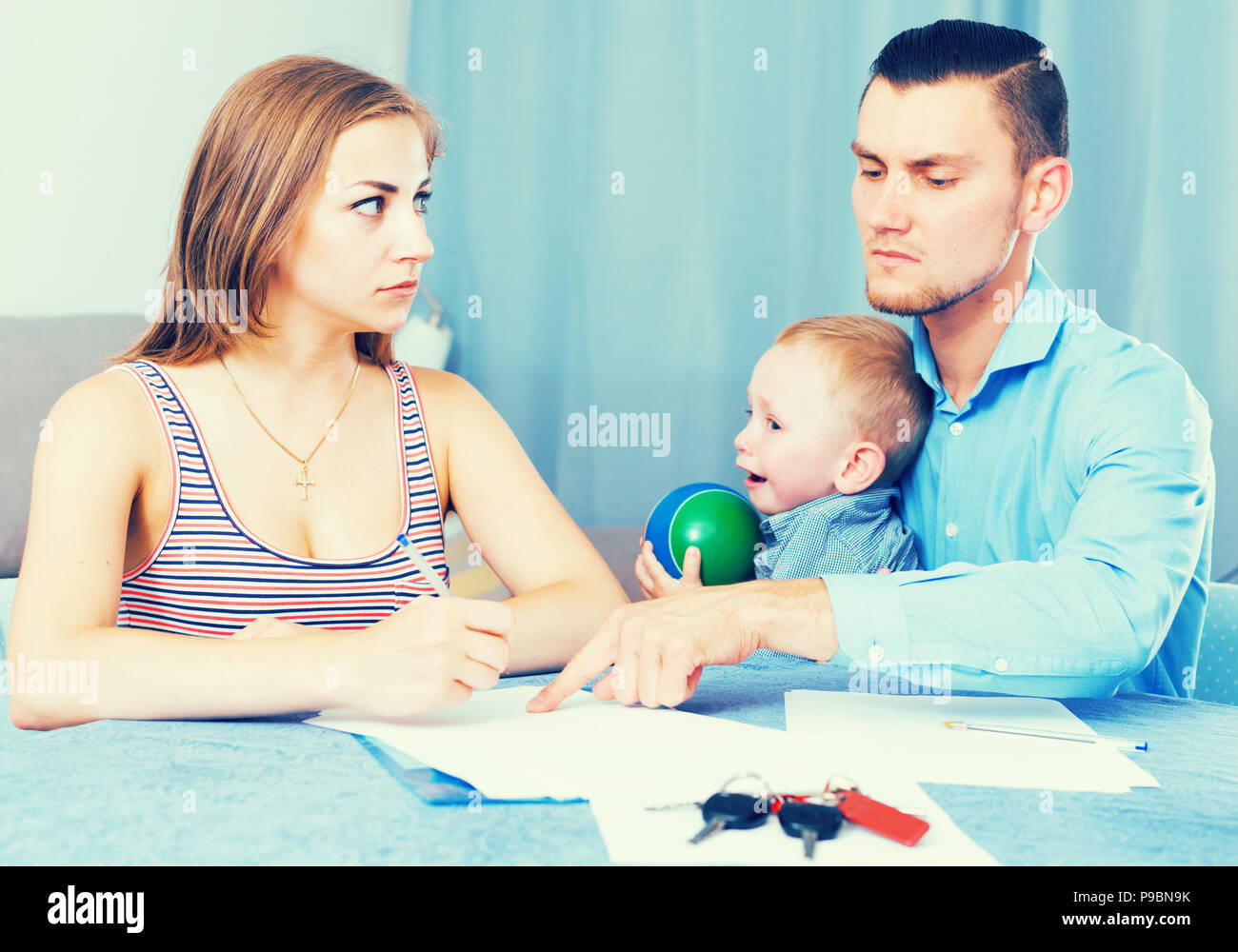 Sad woman with crying boy signing documents about share of property ...