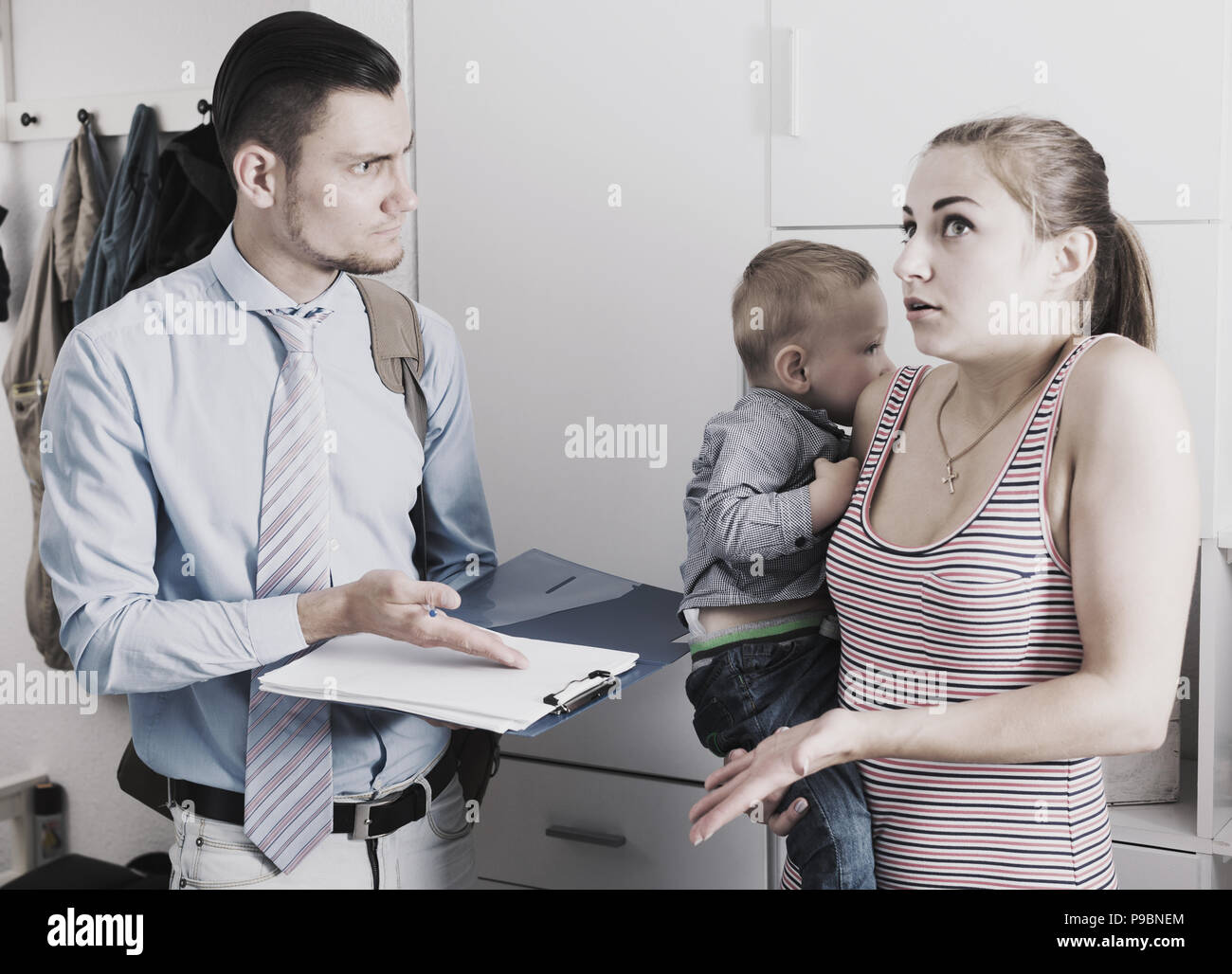 Employee male collector talking with young worrying woman about debt ...
