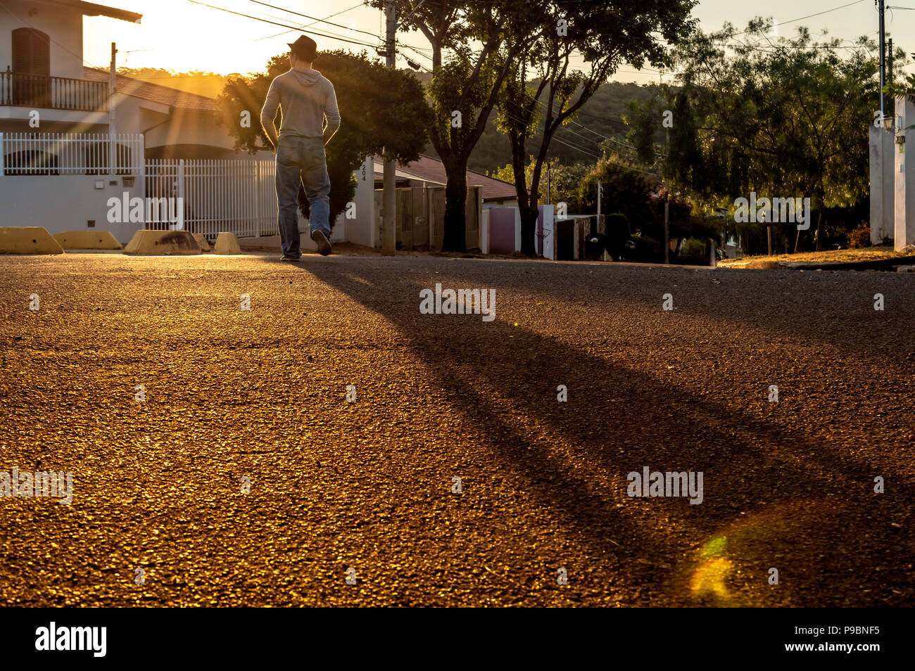Man walking street sun hi-res stock photography and images - Alamy