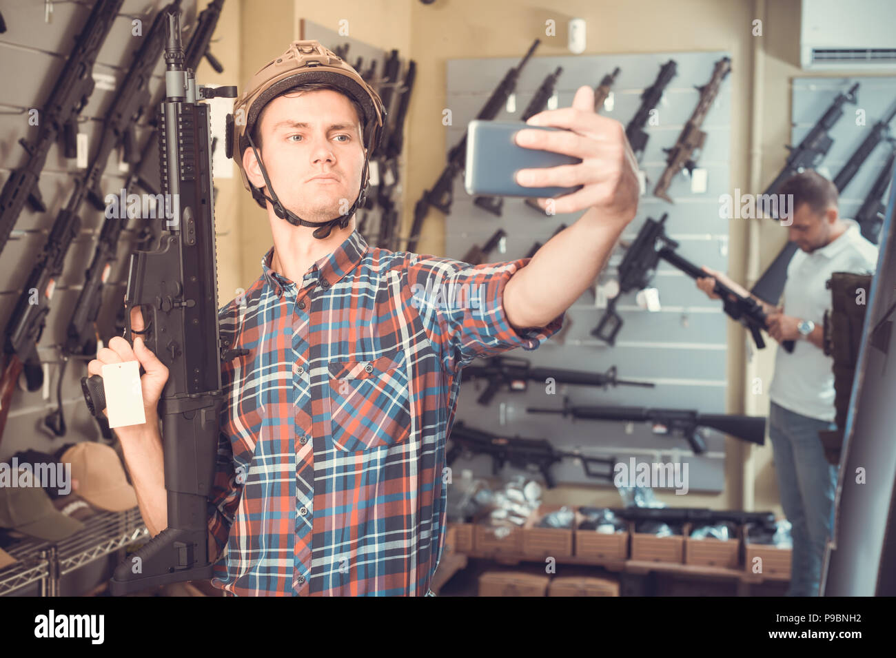 Young man aiming gun camera hi-res stock photography and images - Alamy