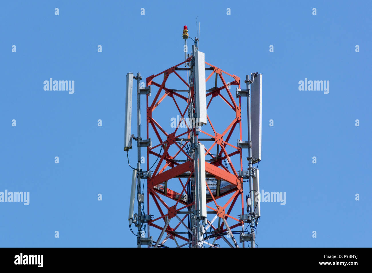 Telecommunications equipment on blue sky background. Directional mobile ...