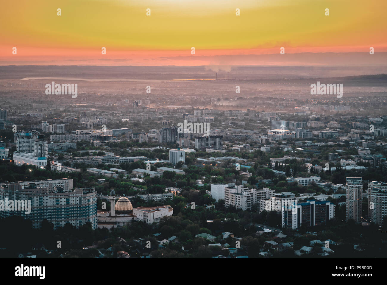 Sunset over the city of Almaty and a view of the Kok Tobe TV Tower ...