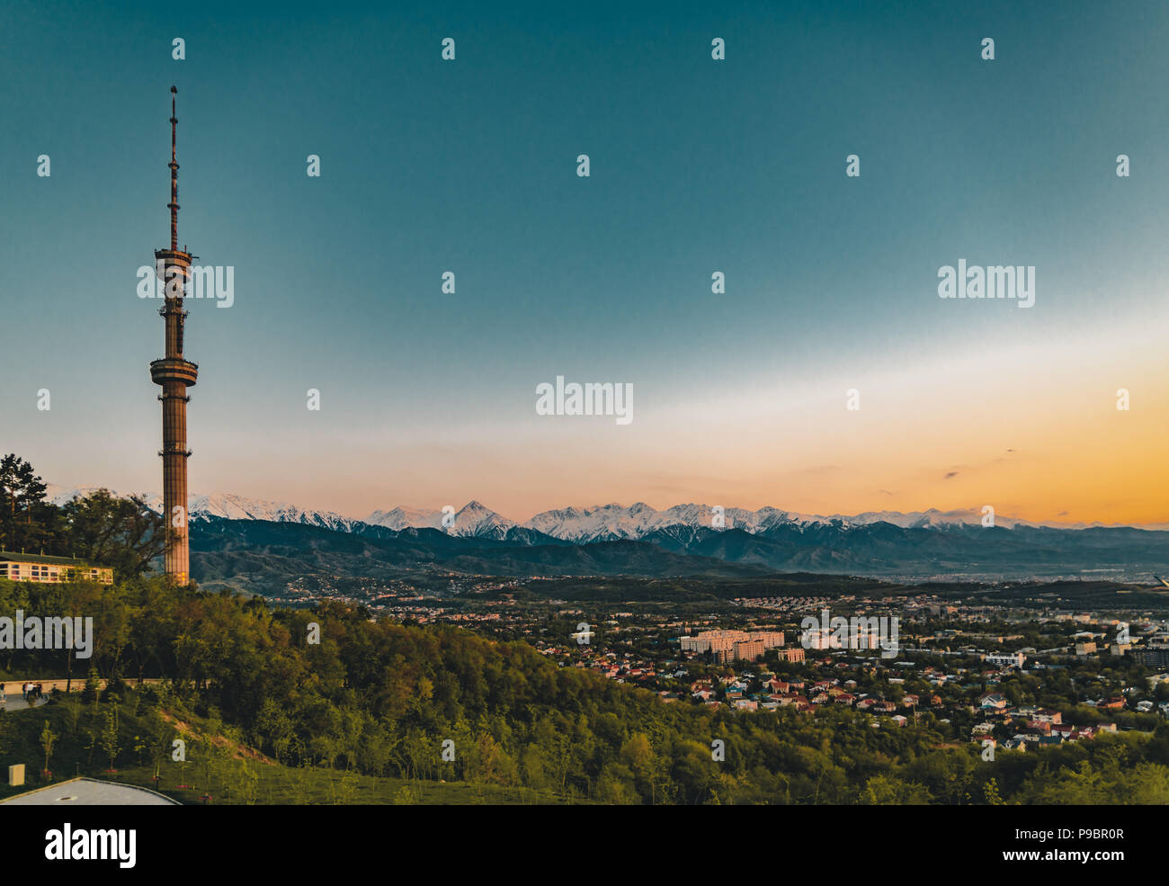 Sunset over the city of Almaty and a view of the Kok Tobe TV Tower ...