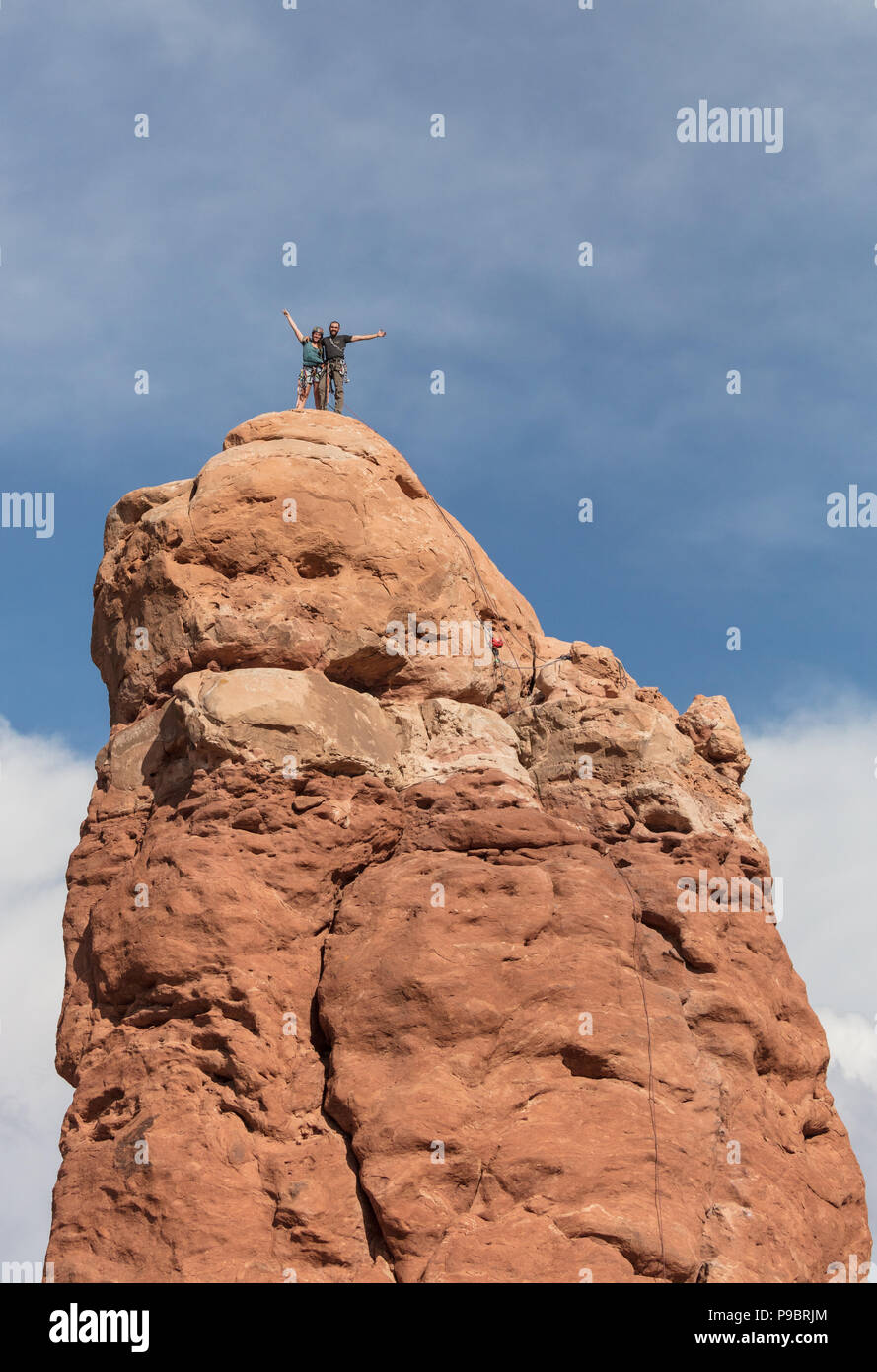 Rock climber scale up Owl Rock in Arches National Park in Utah Stock ...