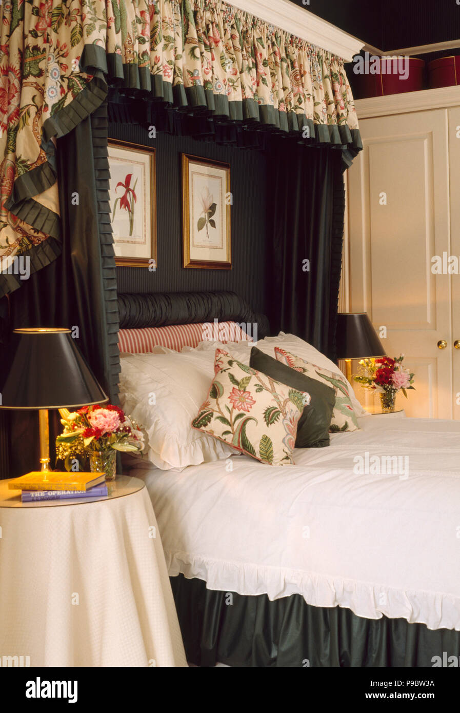 Floral pelmet and green drapes on half-tester bed with white bedlinen ...