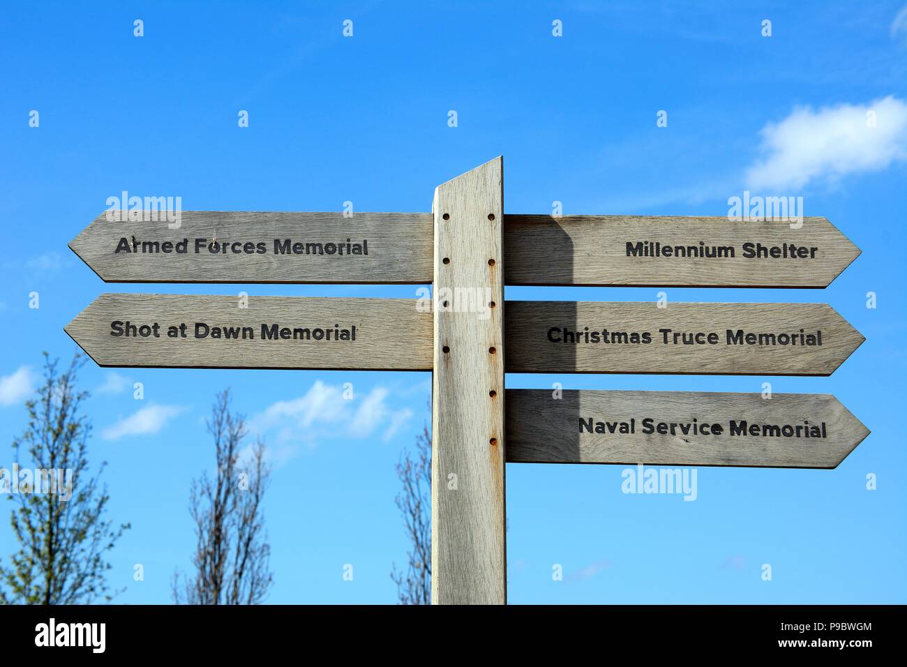Wooden memorials fingerpost sign at the National Memorial Arboretum ...