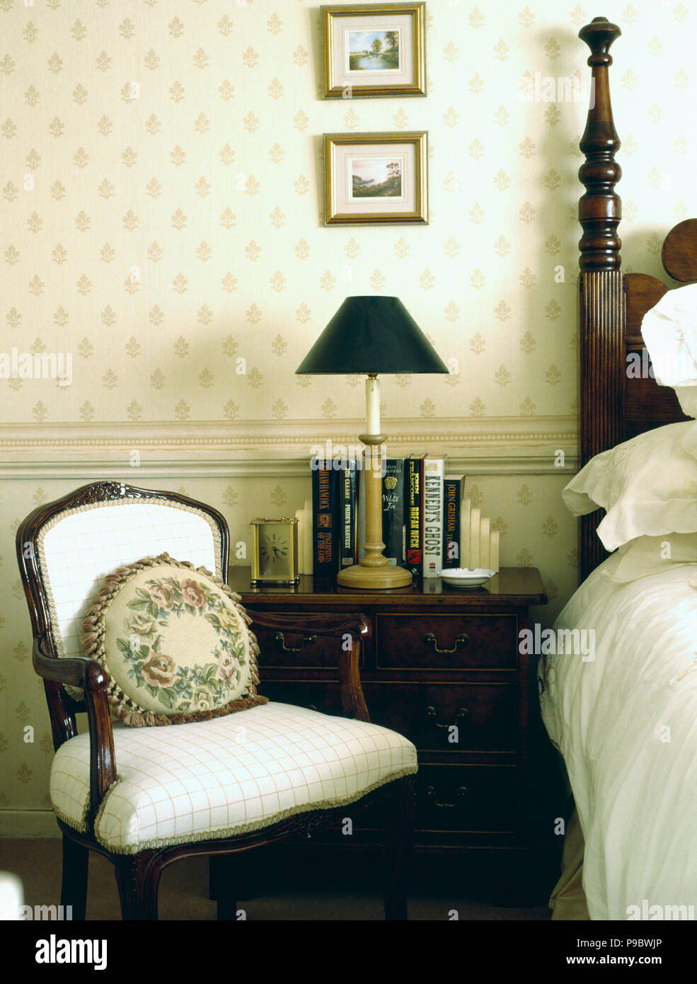 Tapestry cushion on small Victorian chair in traditional bedroom with ...