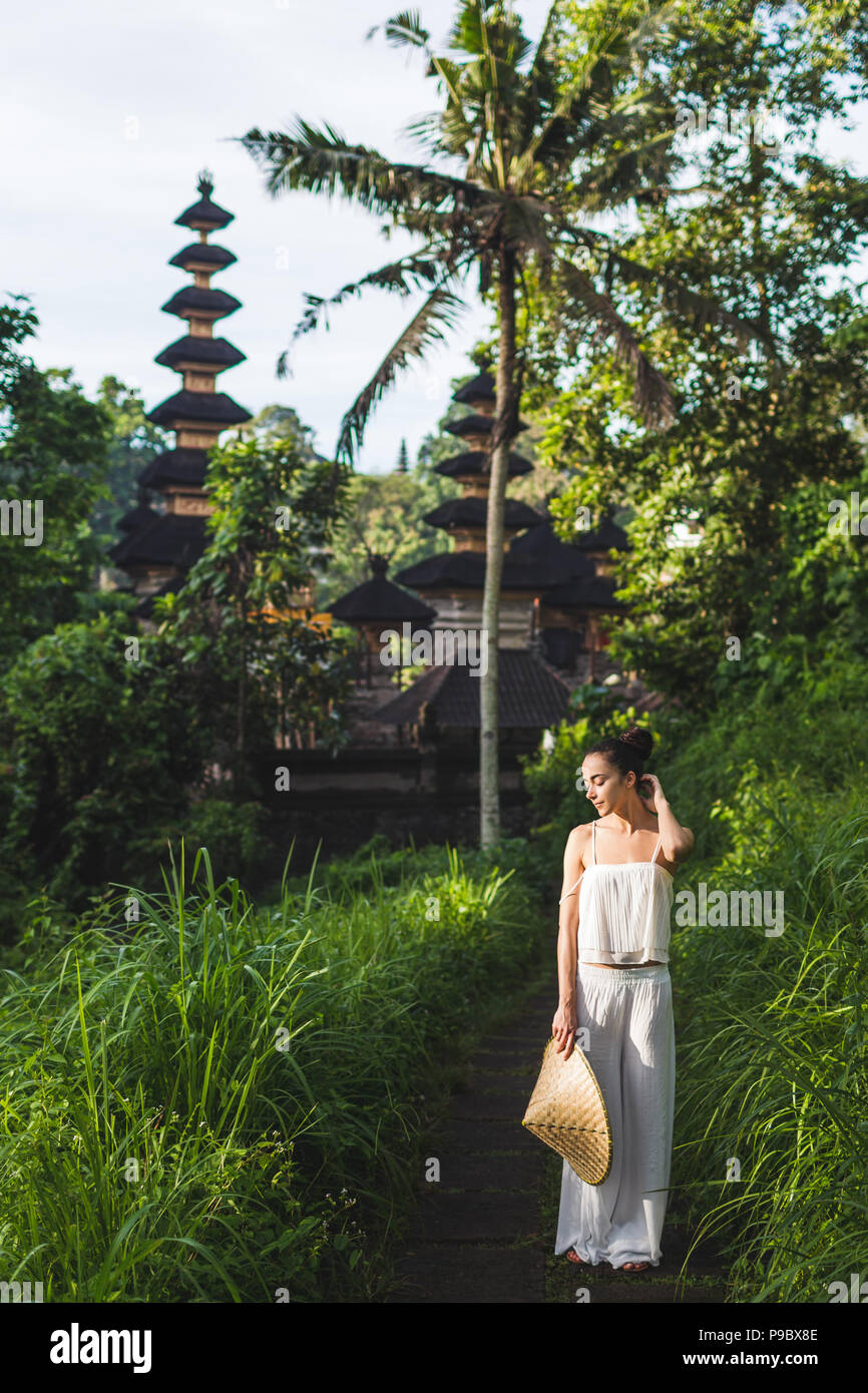 Young beautiful woman walking on Campuhan Ridge way of artists, in Bali ...