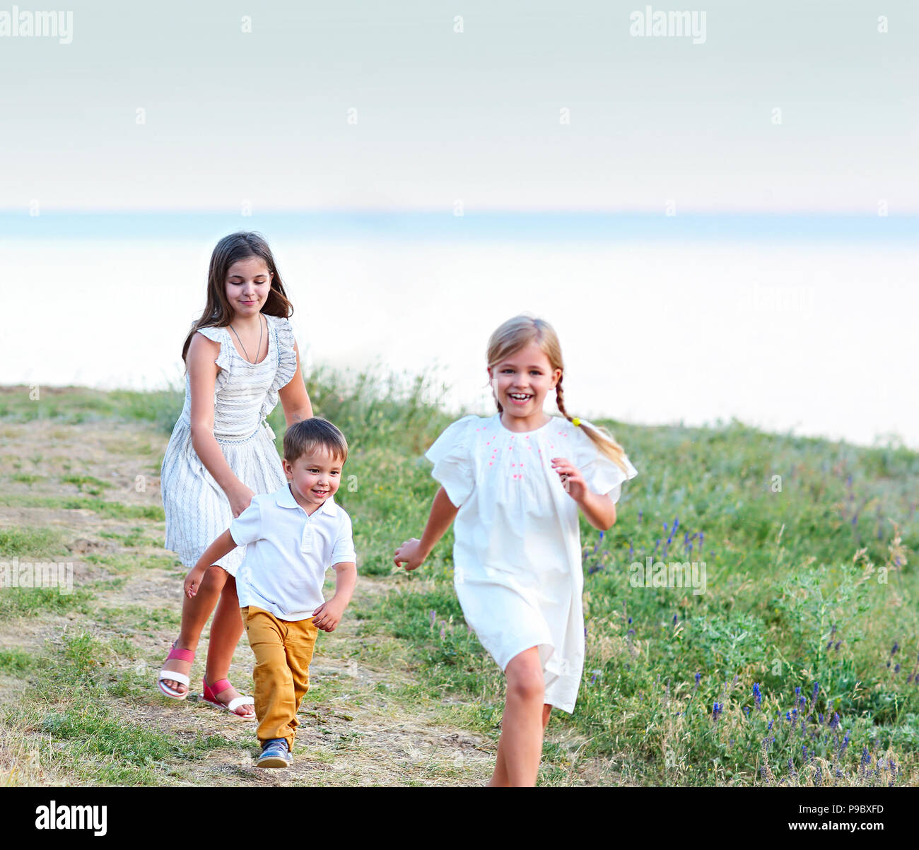 Happy kids playing outside hi-res stock photography and images - Alamy