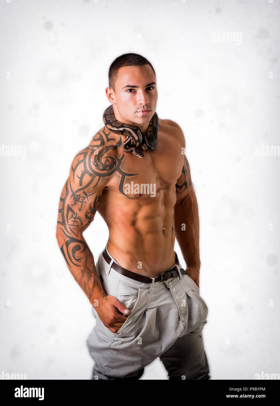 Muscular Man in Camo Pants with Snake Around Neck Stock Photo - Alamy