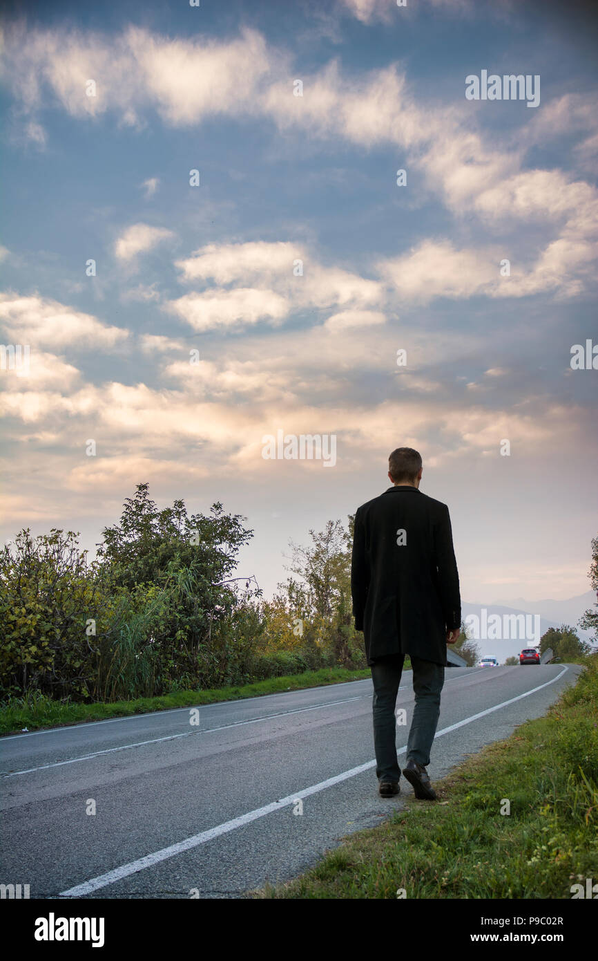 Man walking lonely road hi-res stock photography and images - Alamy