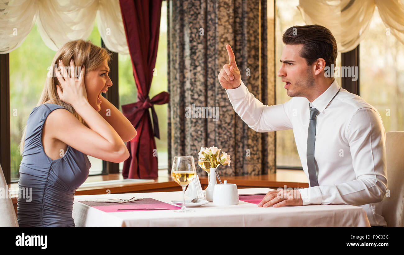 Young couple is arguing at restaurant Stock Photo - Alamy