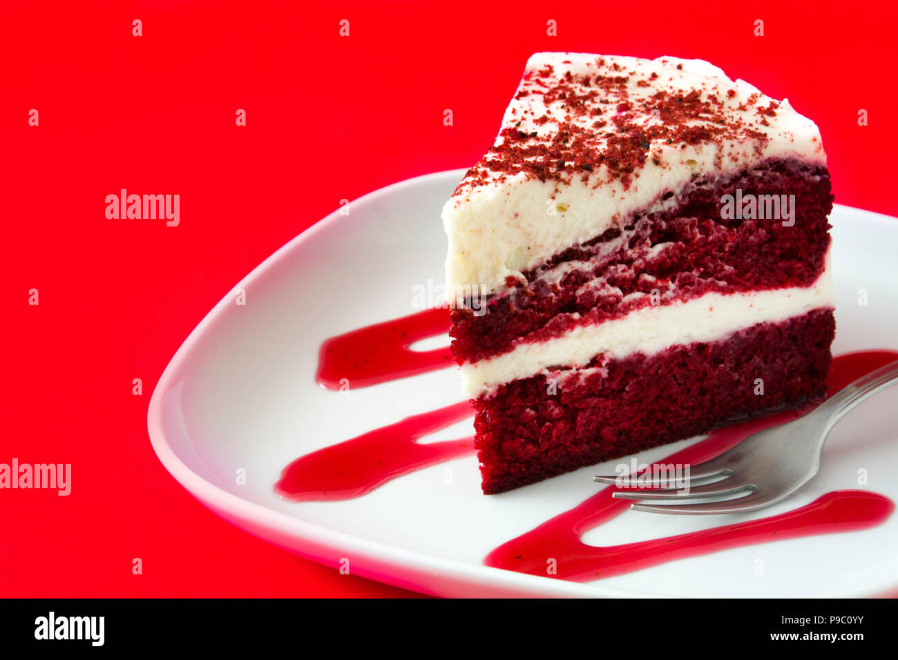 Red Velvet cake slice on red background Stock Photo - Alamy