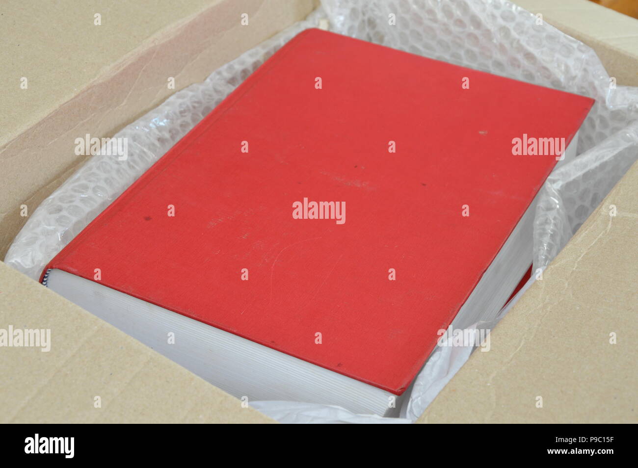 red book in brown paper box Stock Photo - Alamy