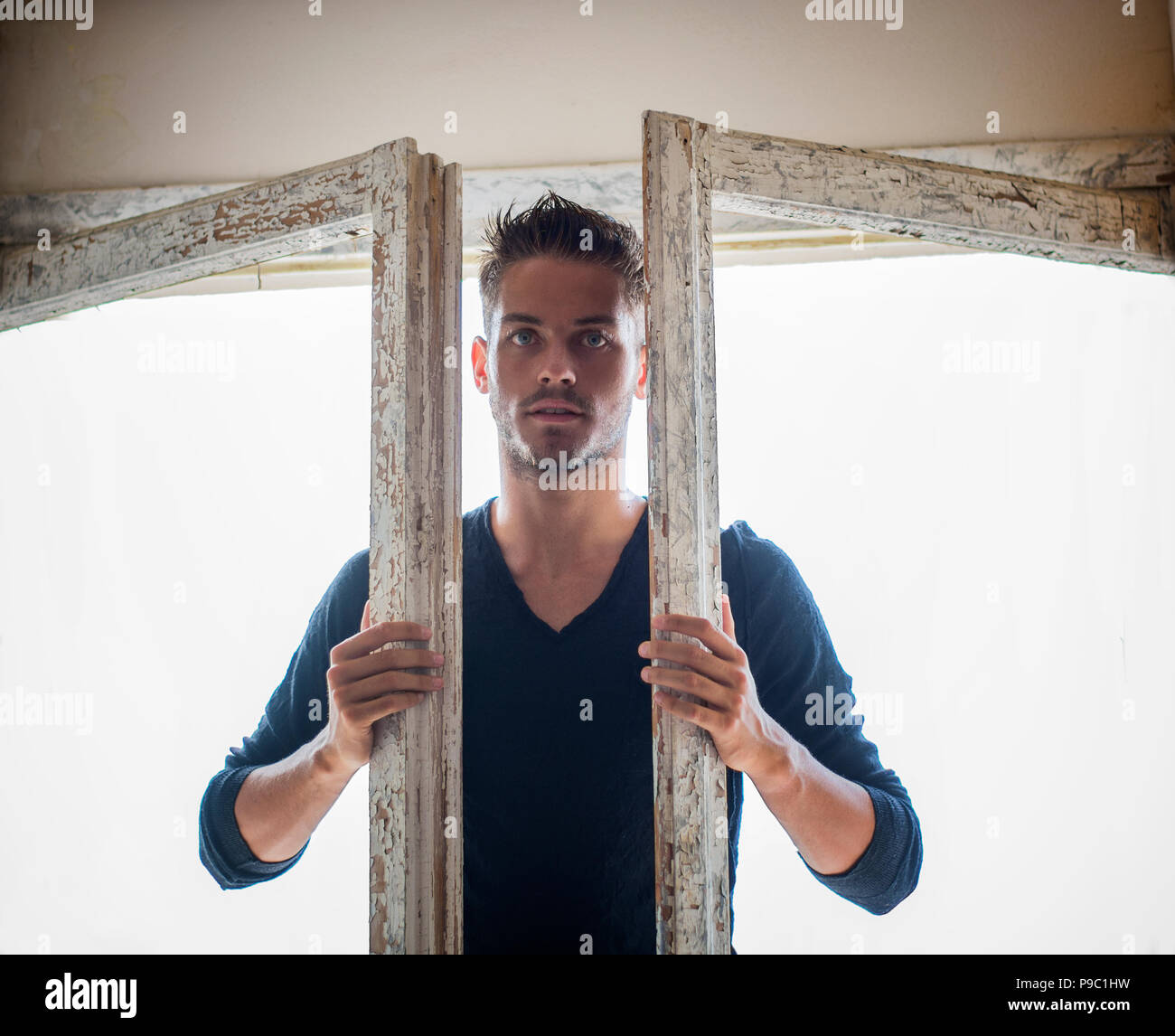 Handsome man walking in doors Stock Photo - Alamy