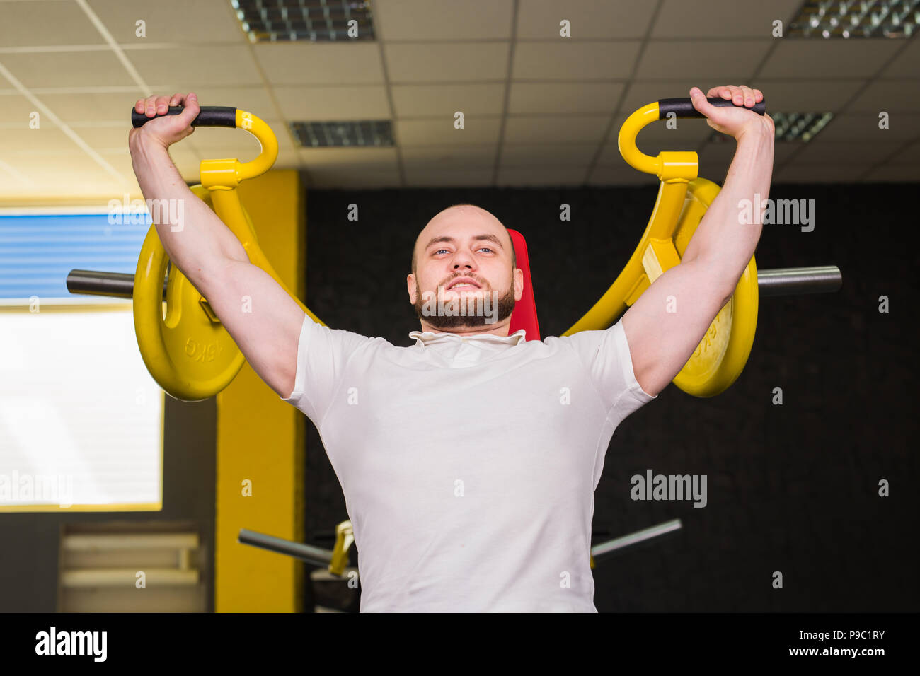 Sport, fitness, training and people concept - Man doing heavy exercise ...