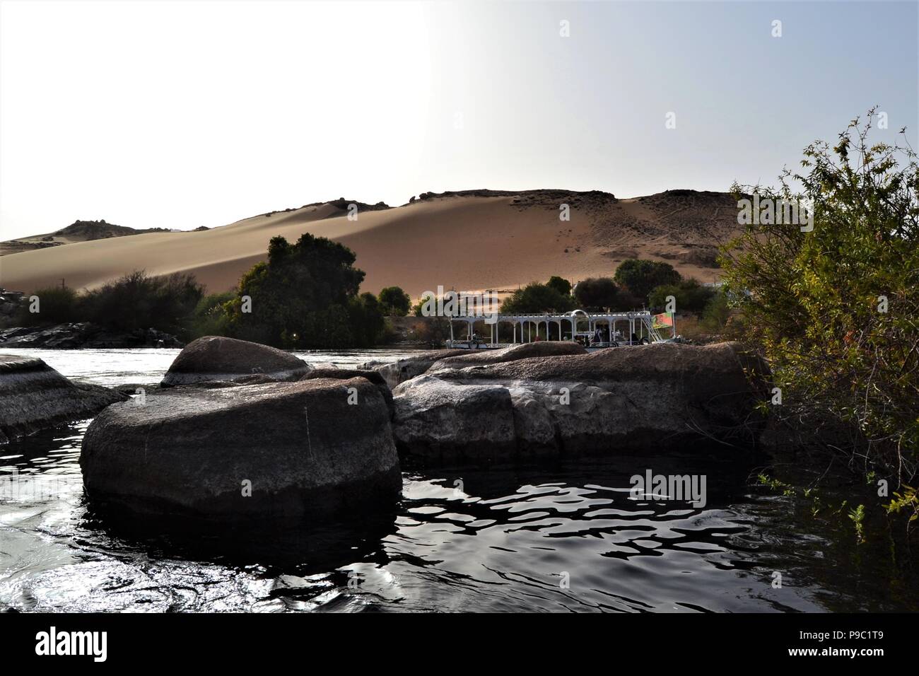 Reflections on water by the rocks on the River Nile Stock Photo - Alamy