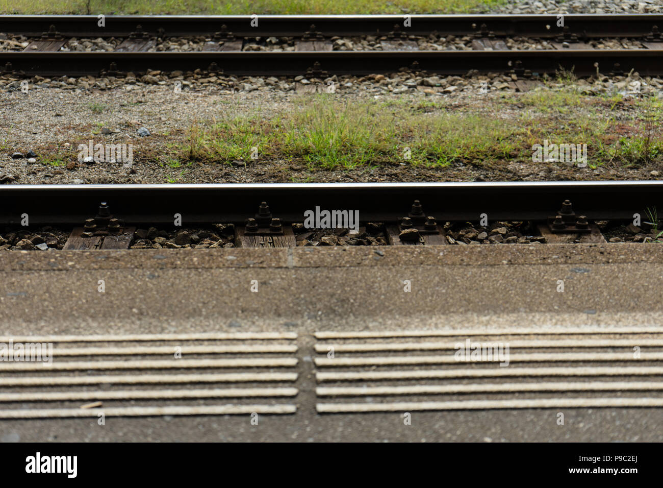railway station train track close up with blind people marking Stock ...