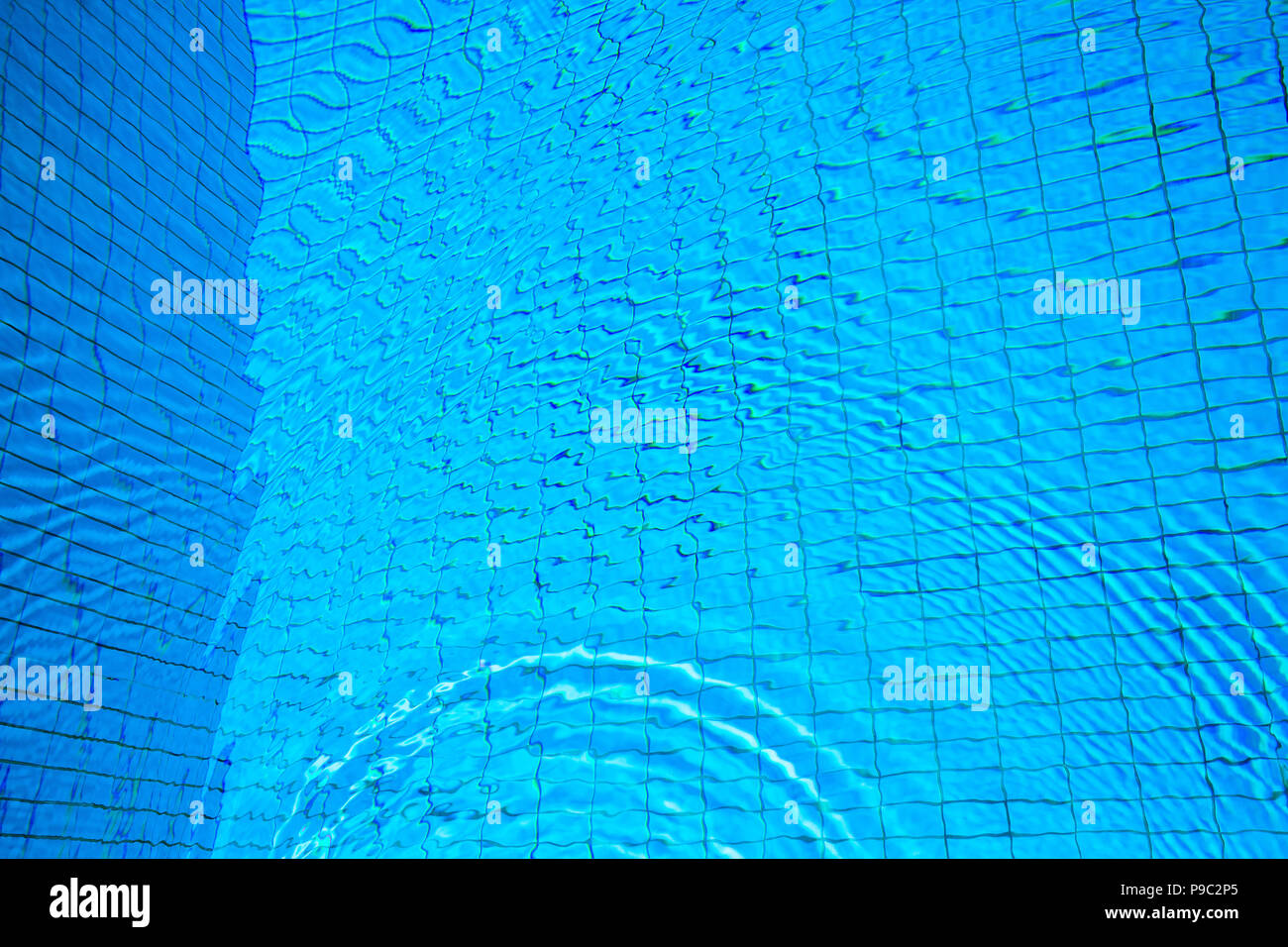 Ripples movement in a deep swimming pool with wavy shadows and light ...