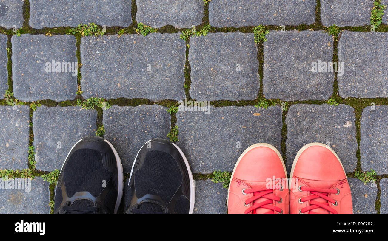 On the paving stones are opposite each other a pair of shoes, top view ...