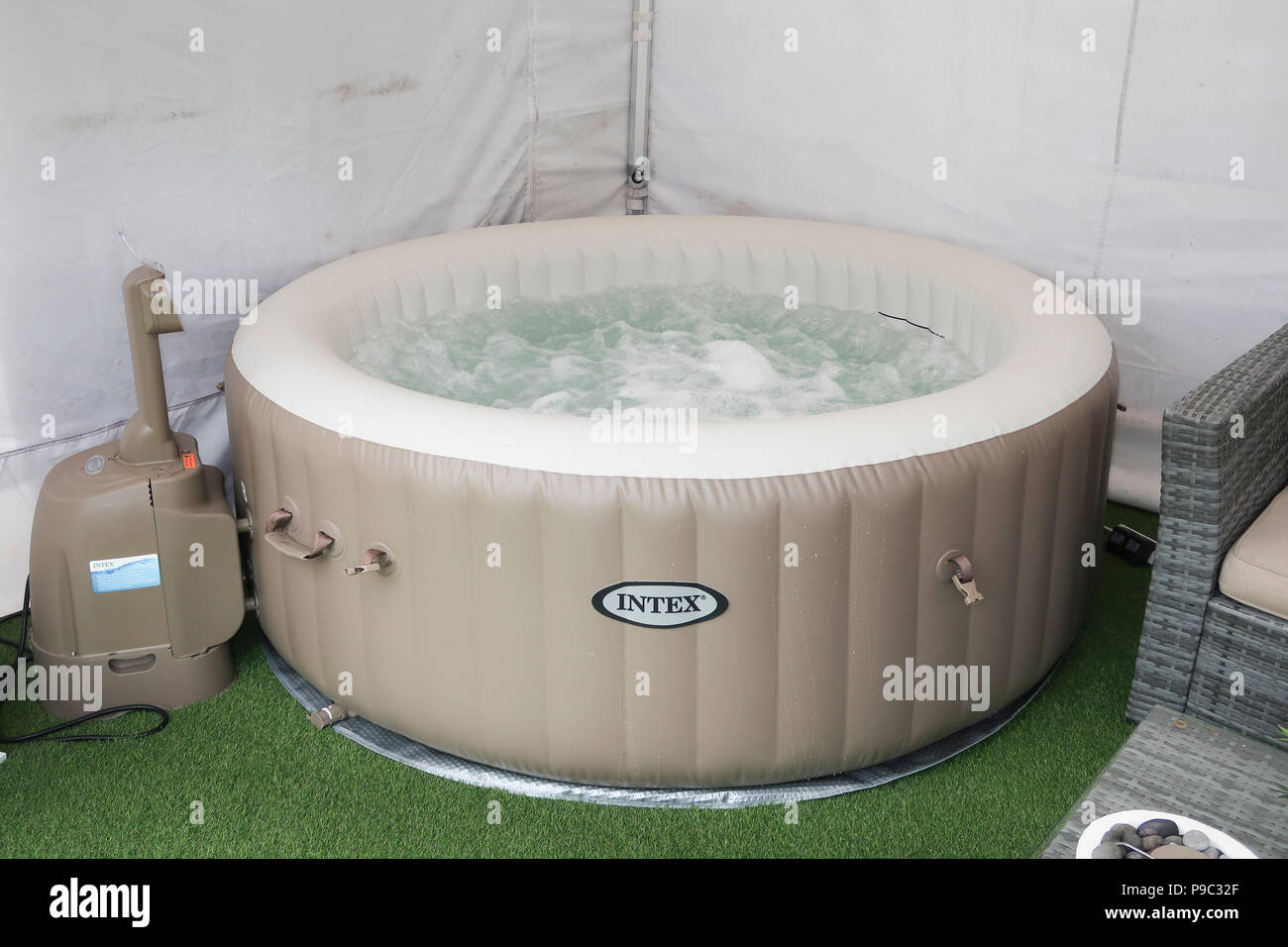 Inflatable hot tub in garden gazebo Stock Photo - Alamy