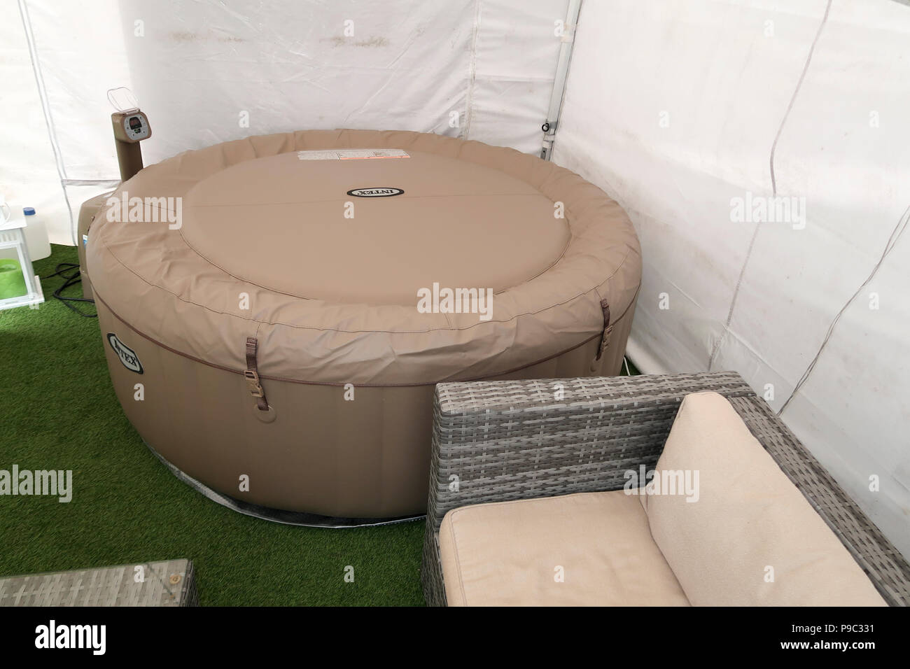 Inflatable hot tub in garden gazebo Stock Photo - Alamy