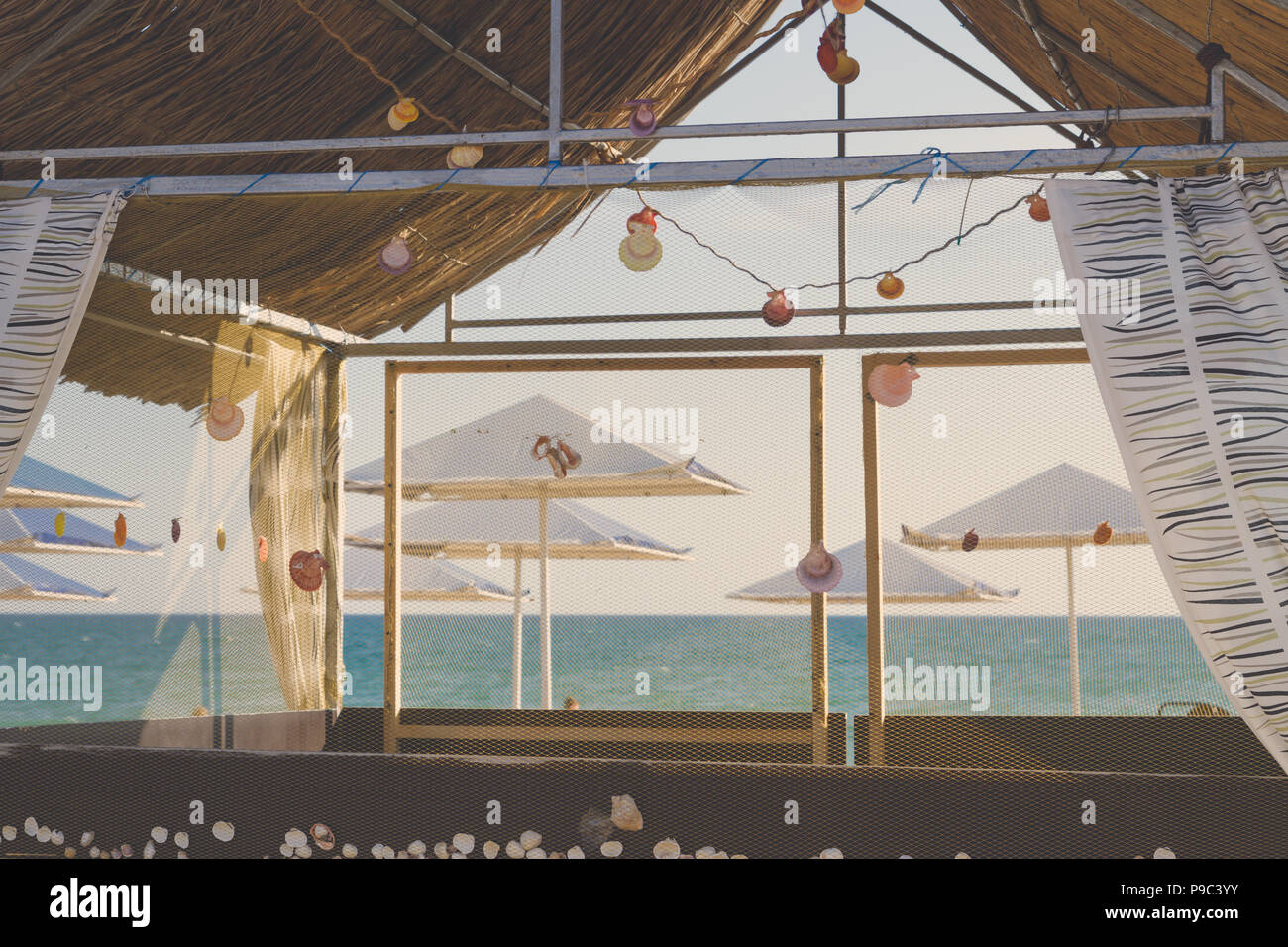 Wooden beach house decorated with sea shells on the beach Stock Photo ...