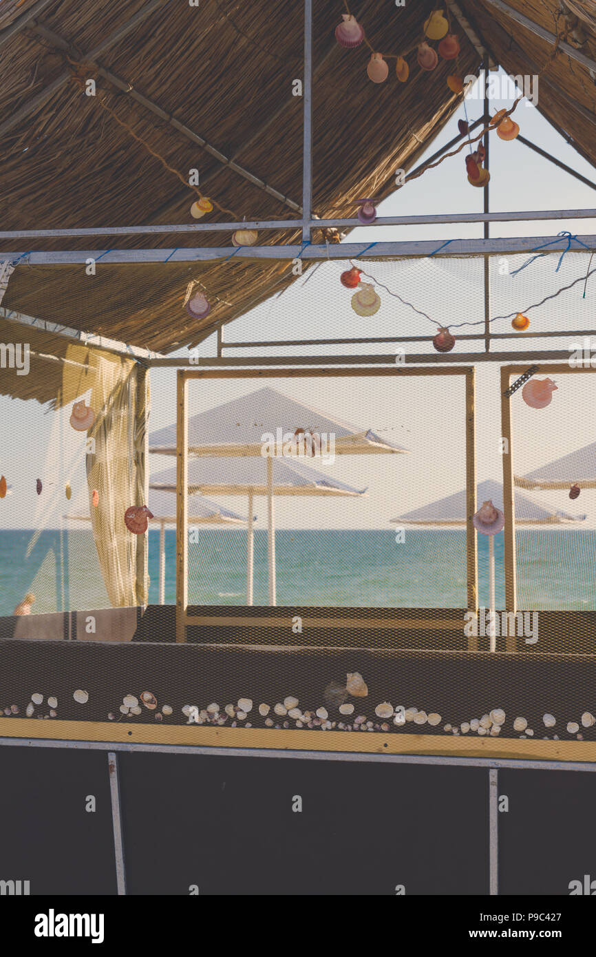 Wooden beach house decorated with sea shells on the beach Stock Photo ...