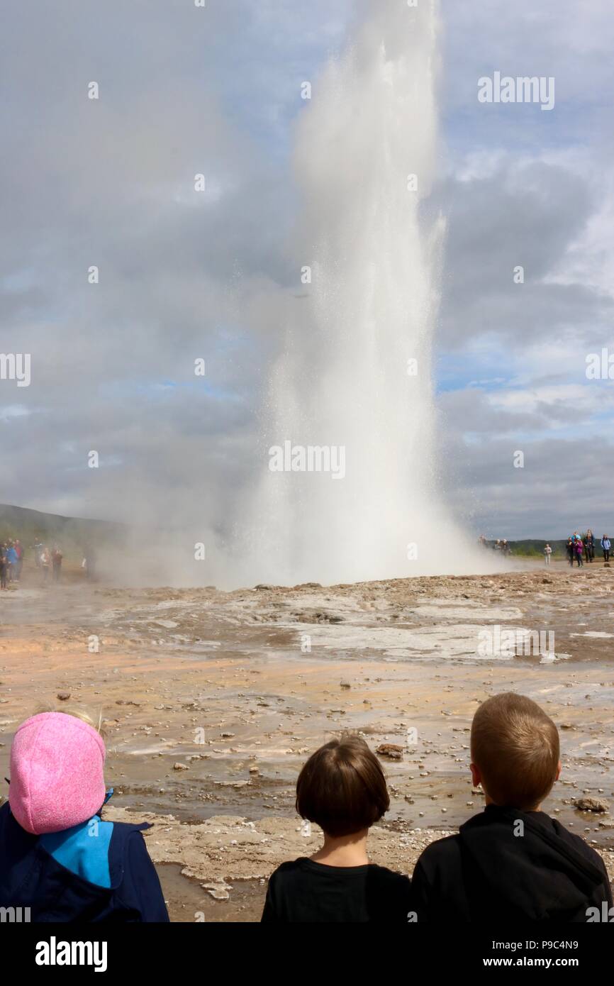Children watching geyser erupt Stock Photo - Alamy