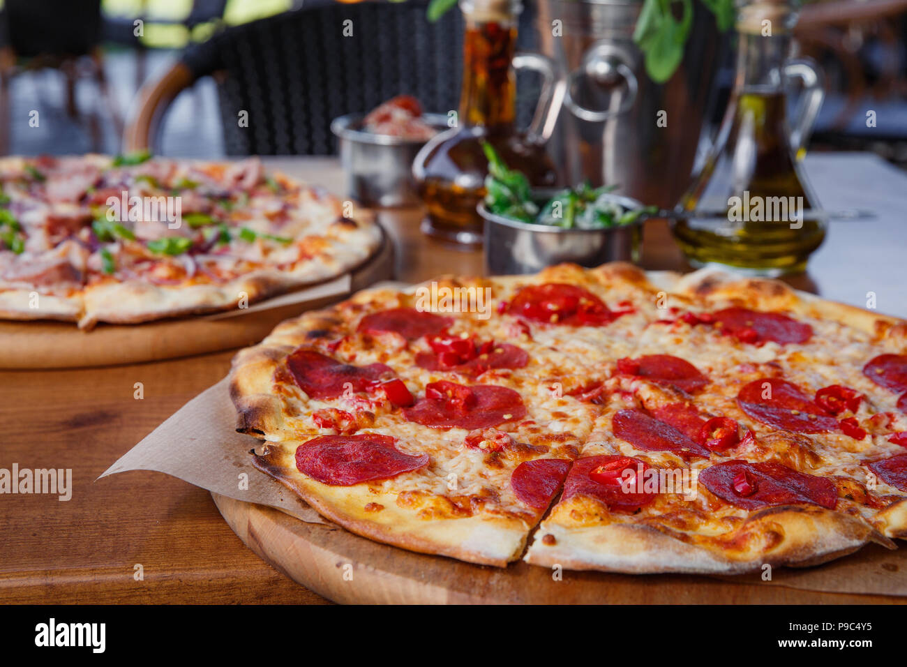 Hot delicious pepperoni pizza on wooden restaurant table Stock Photo ...
