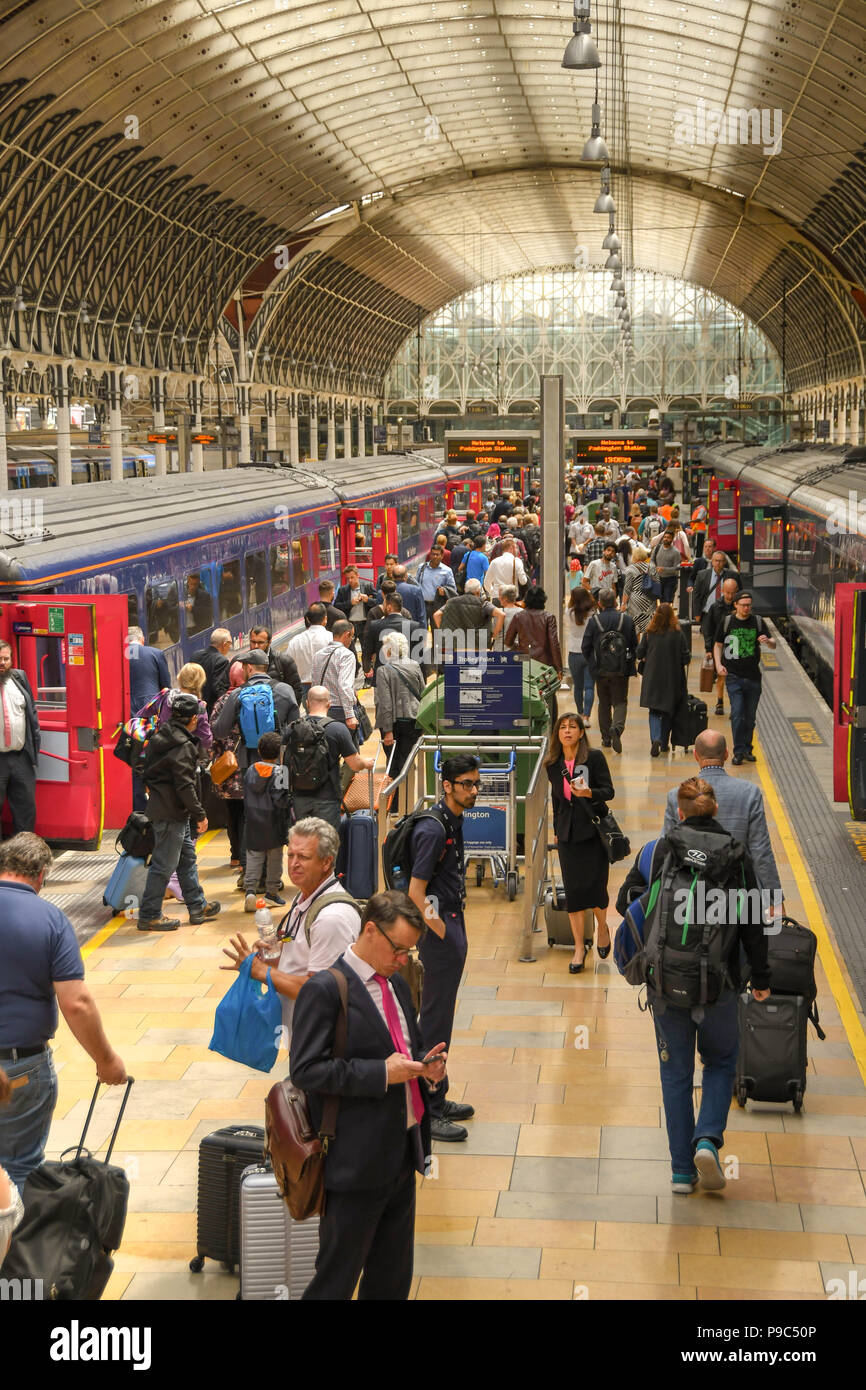 Passengers walking along a platform after getting off a train in London ...