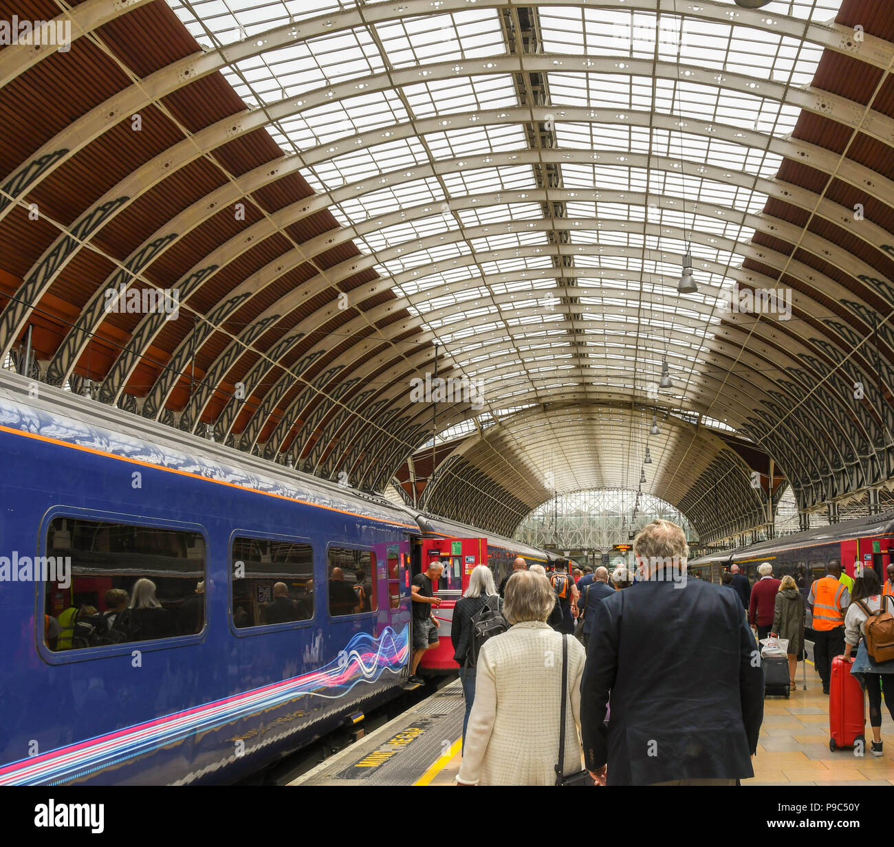 Passengers walking along a platform after getting off a train in London ...