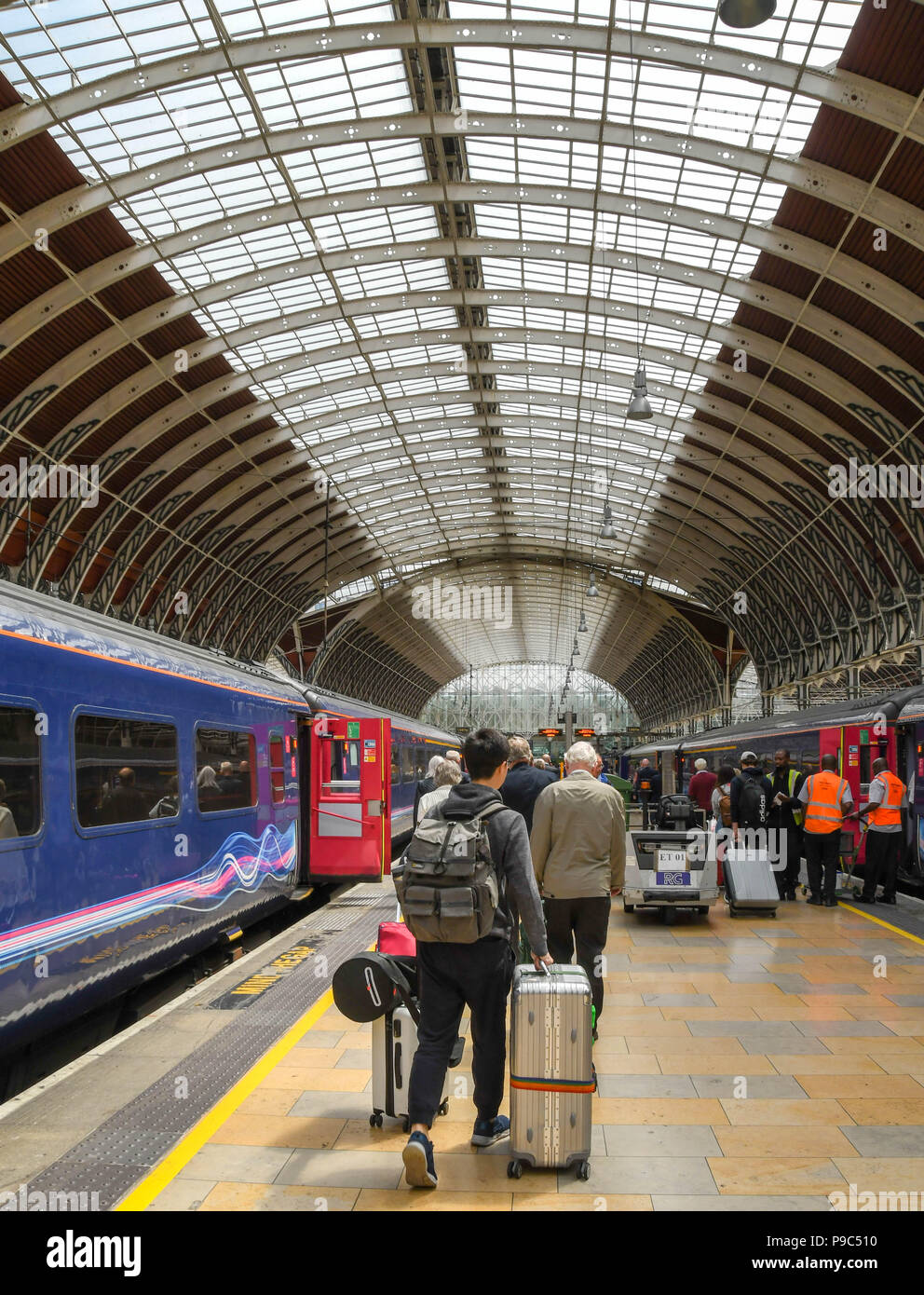 Passengers walking along a platform in London Paddington railway ...