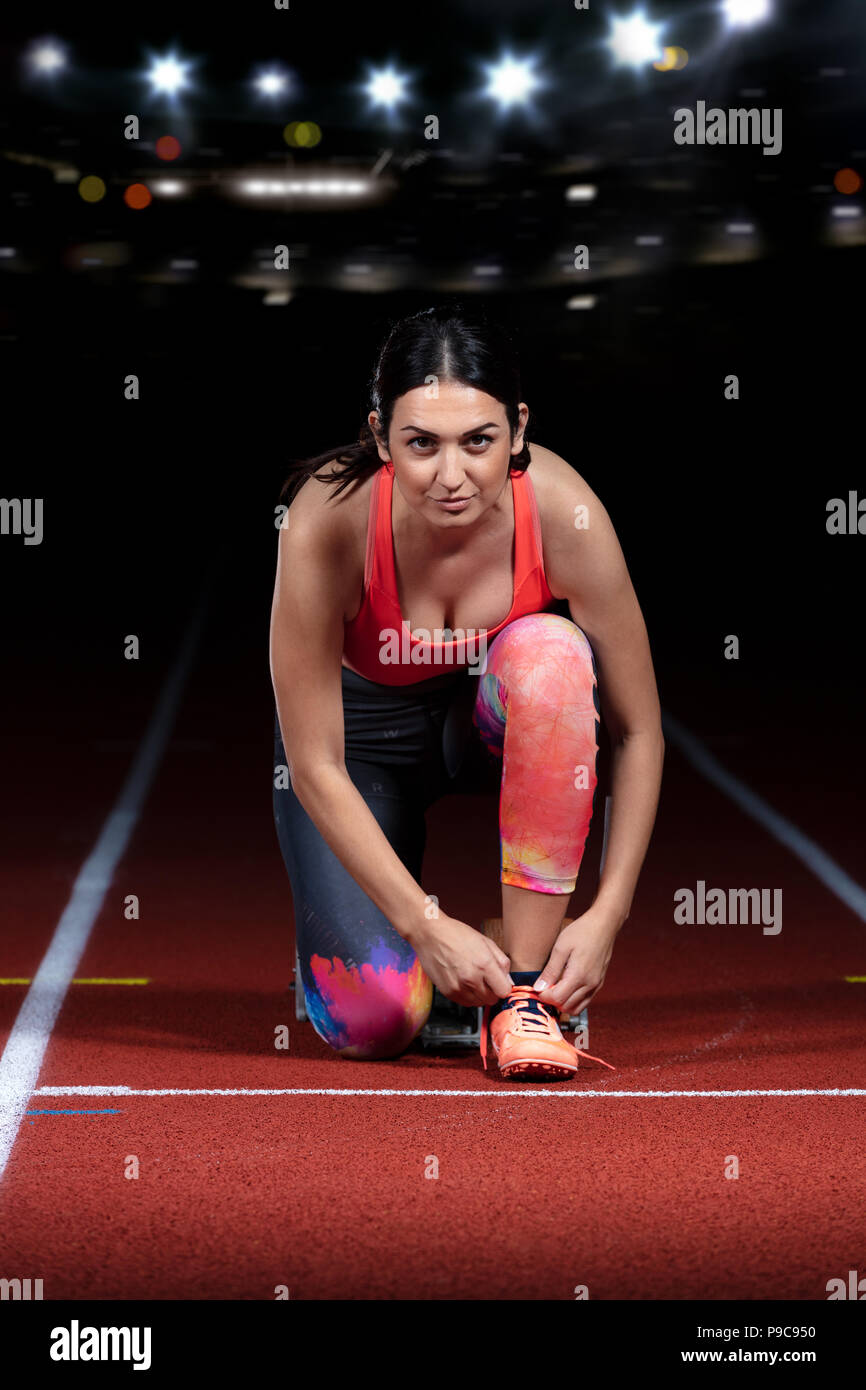 Athlete girl trying running shoes getting ready for race on track Stock ...