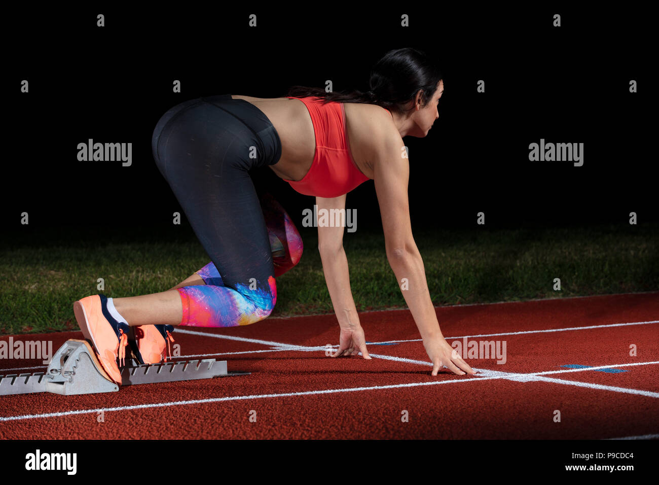 Female sprinter leaving starting blocks hi-res stock photography and ...