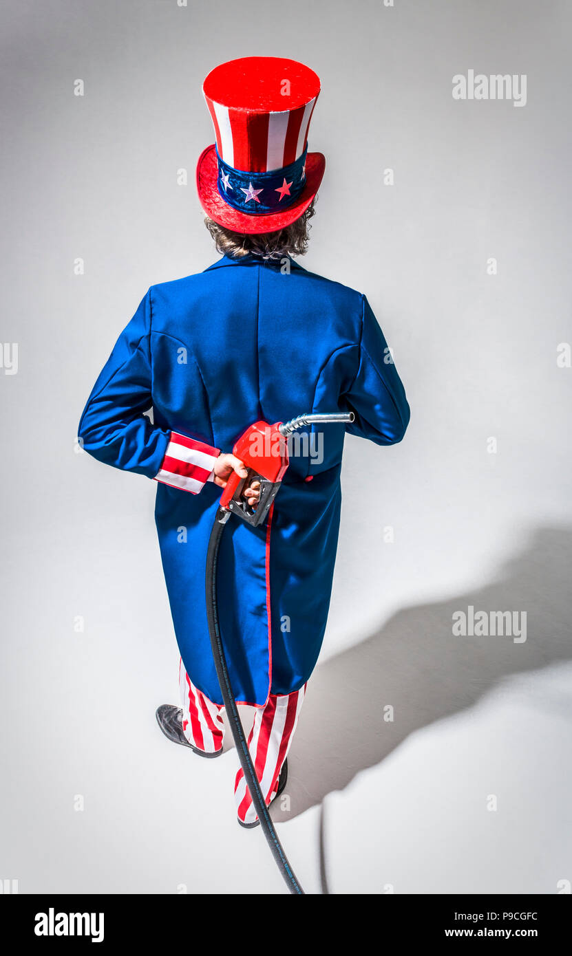 Uncle Sam character as seen from behind holding a gasoline pump nozzle behind his back Stock ...