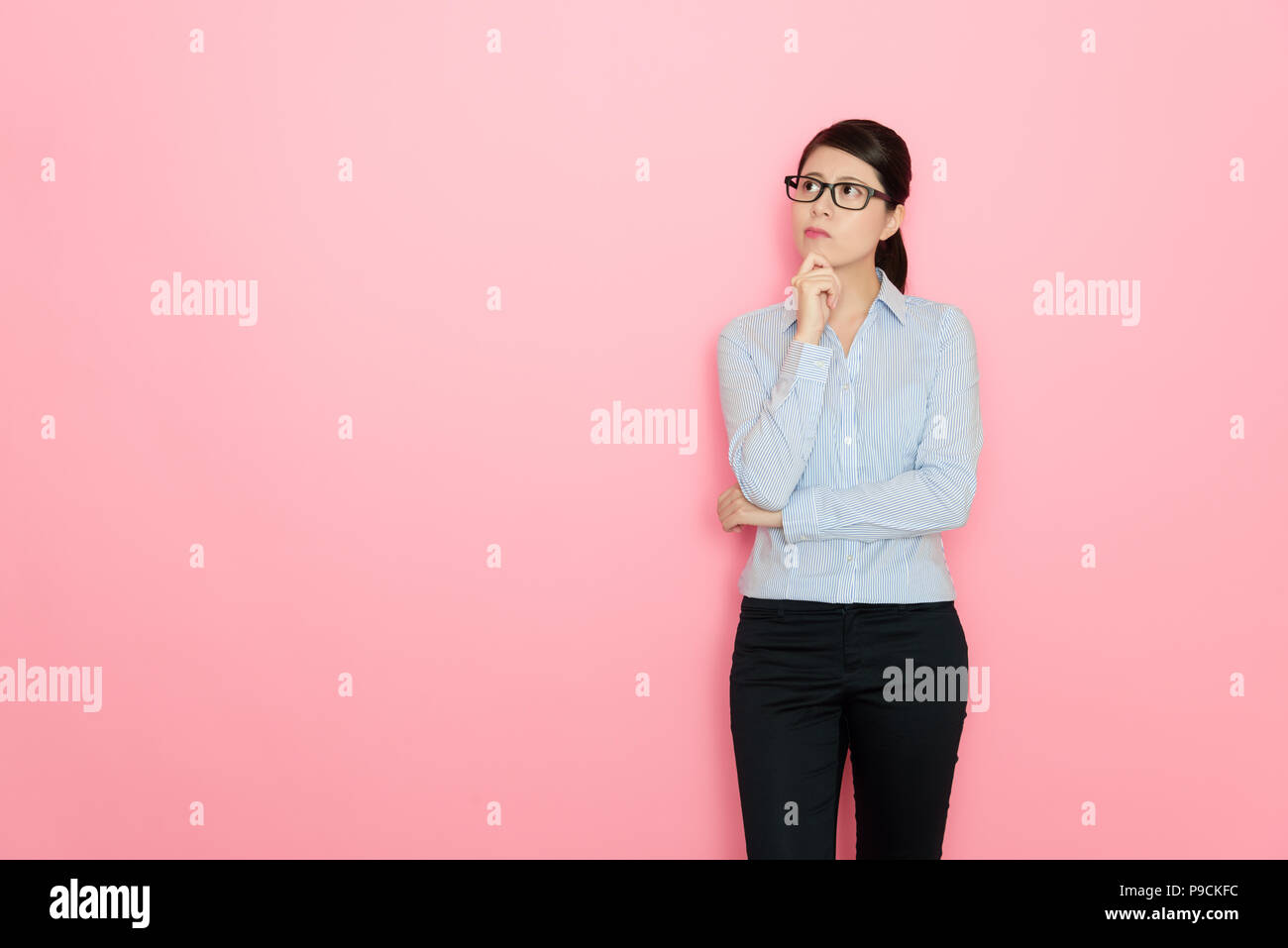 beautiful Asian businesswoman standing on pink background showing the ...