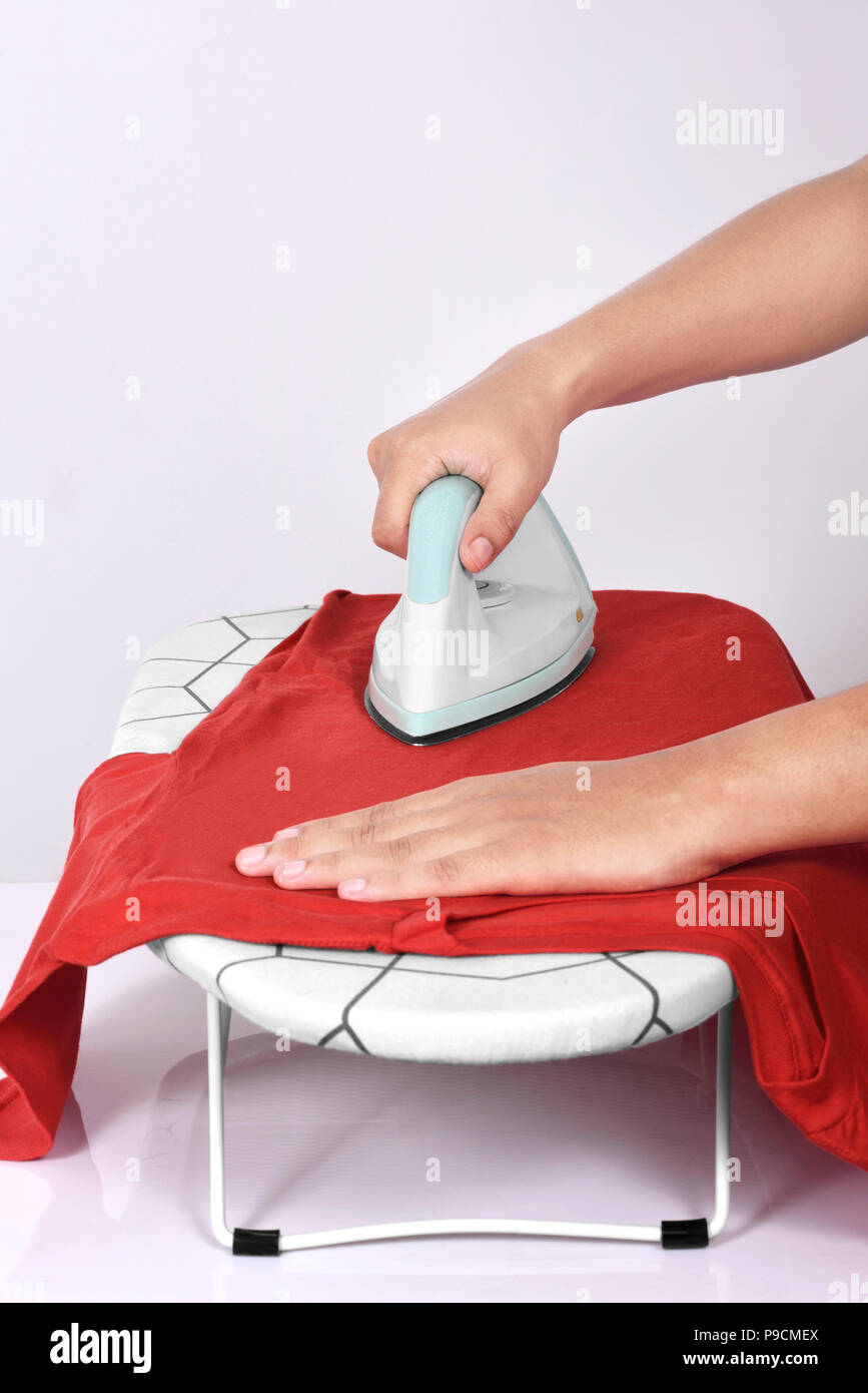 People ironing colored clothes on ironing board isolated over white ...