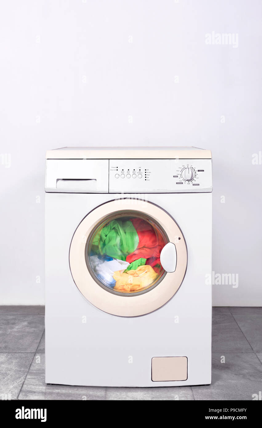 Dirty clothes washed on washing machine. Home appliances Stock Photo ...