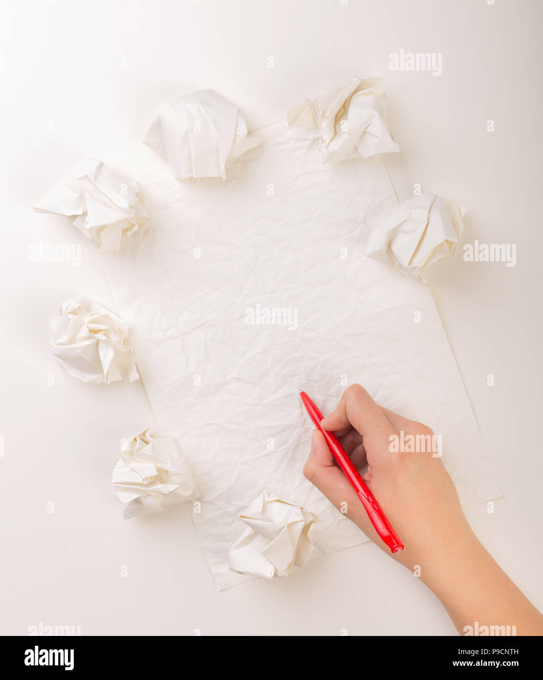Female hand trying to write next to a few crumpled paper balls Stock ...