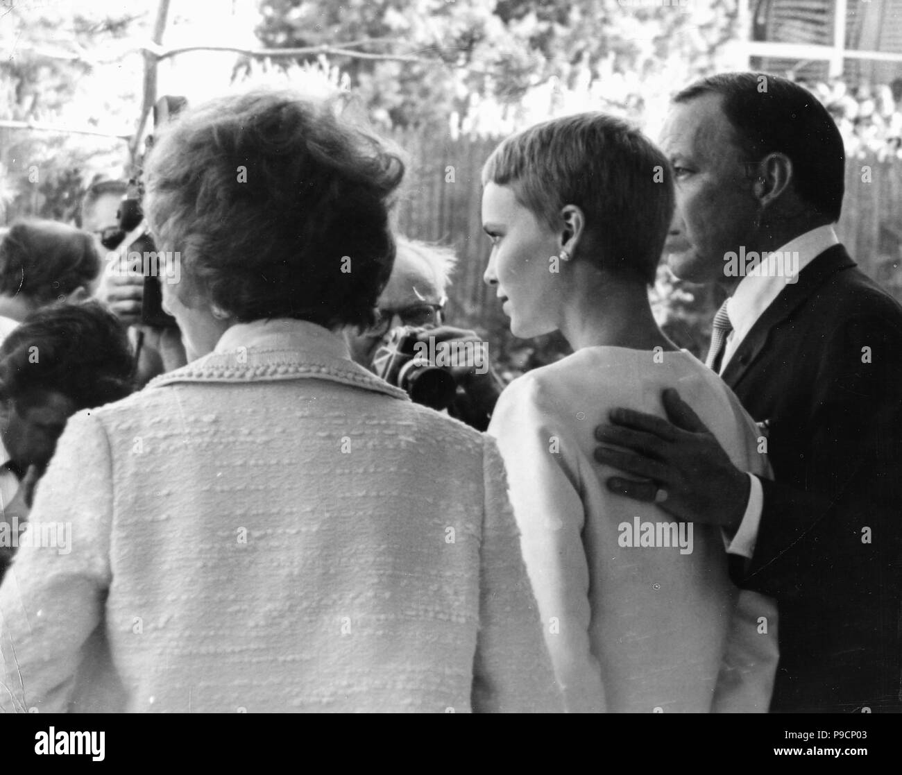 frank sinatra, mia farrow and edith mayer, surrounded by the press on ...