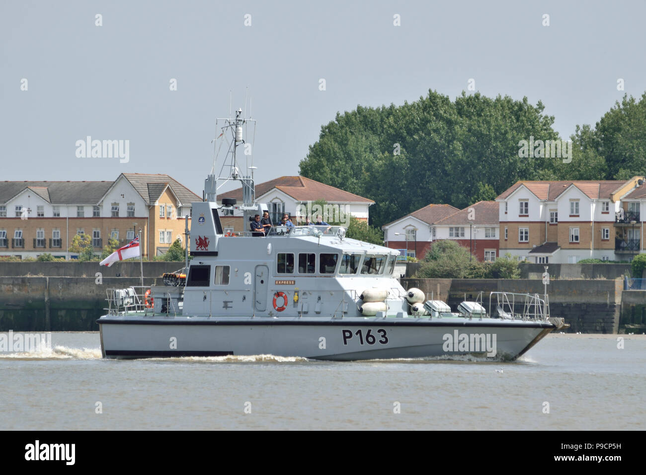 Royal Navy Inshore Patrol Vessel HMS Express heads up the River Thames ...
