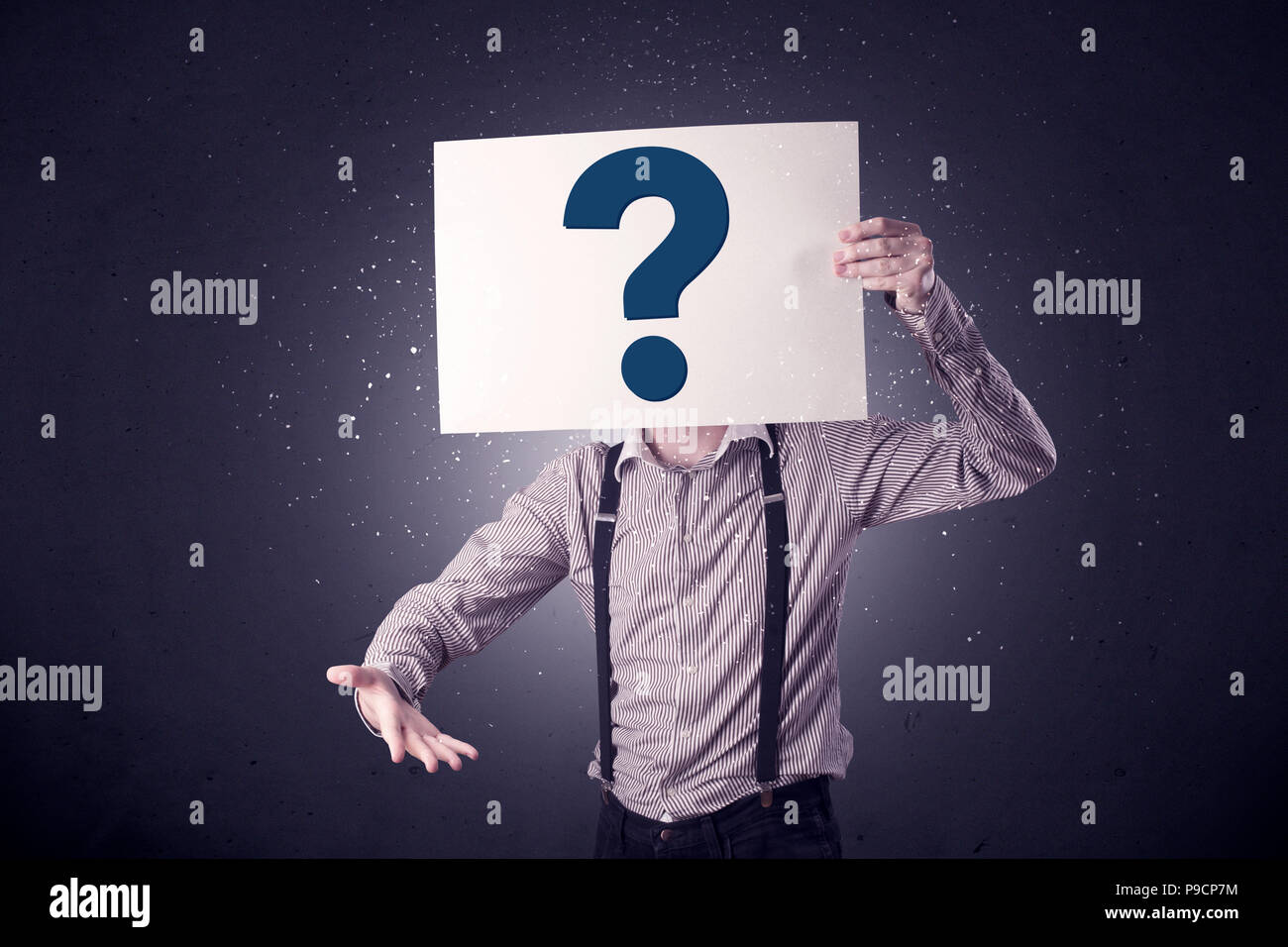 Young businessman hiding behind a question mark drawn on paper Stock ...