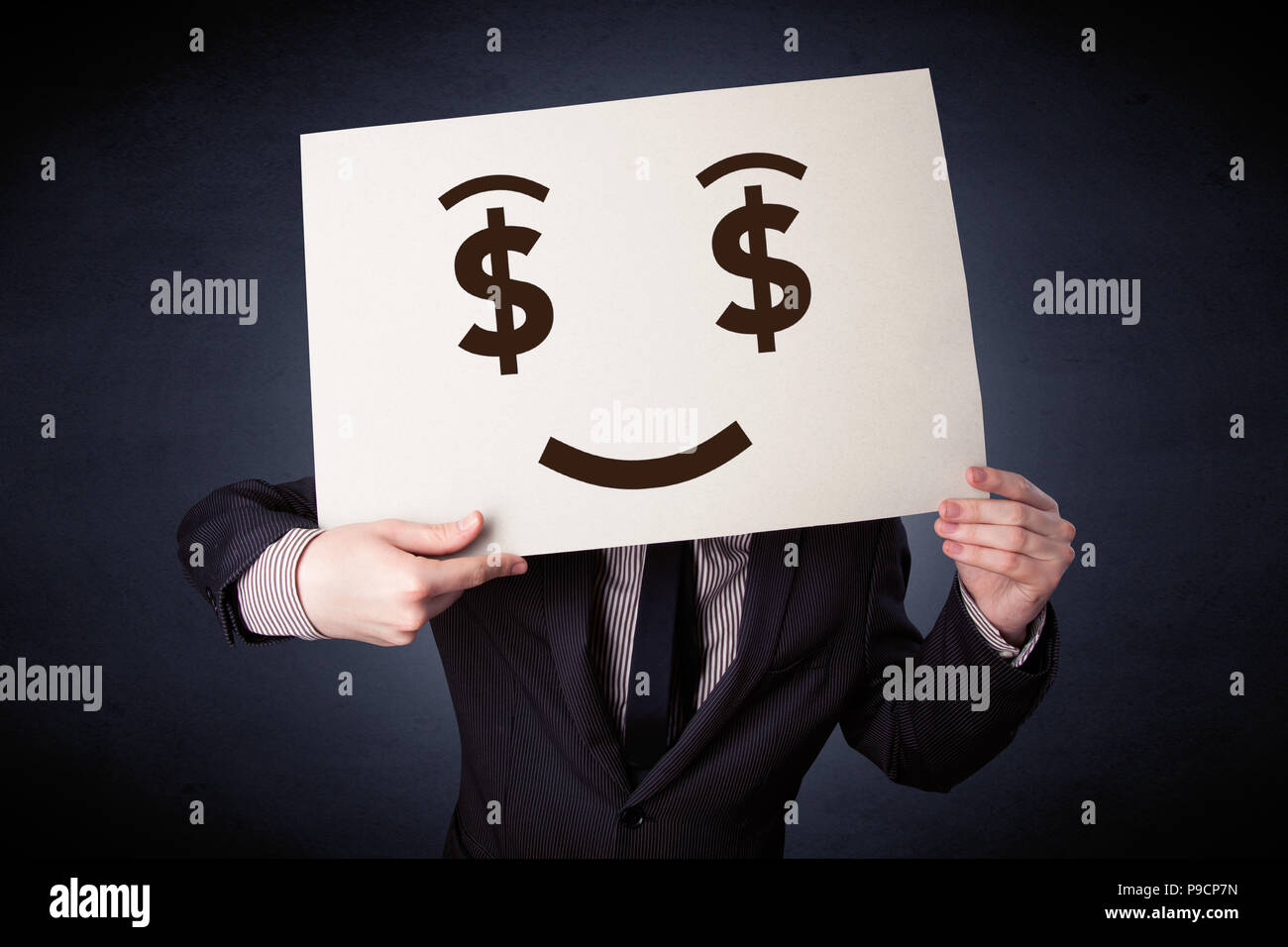 Young casual businessman hiding behind a greedy face drawing on ...