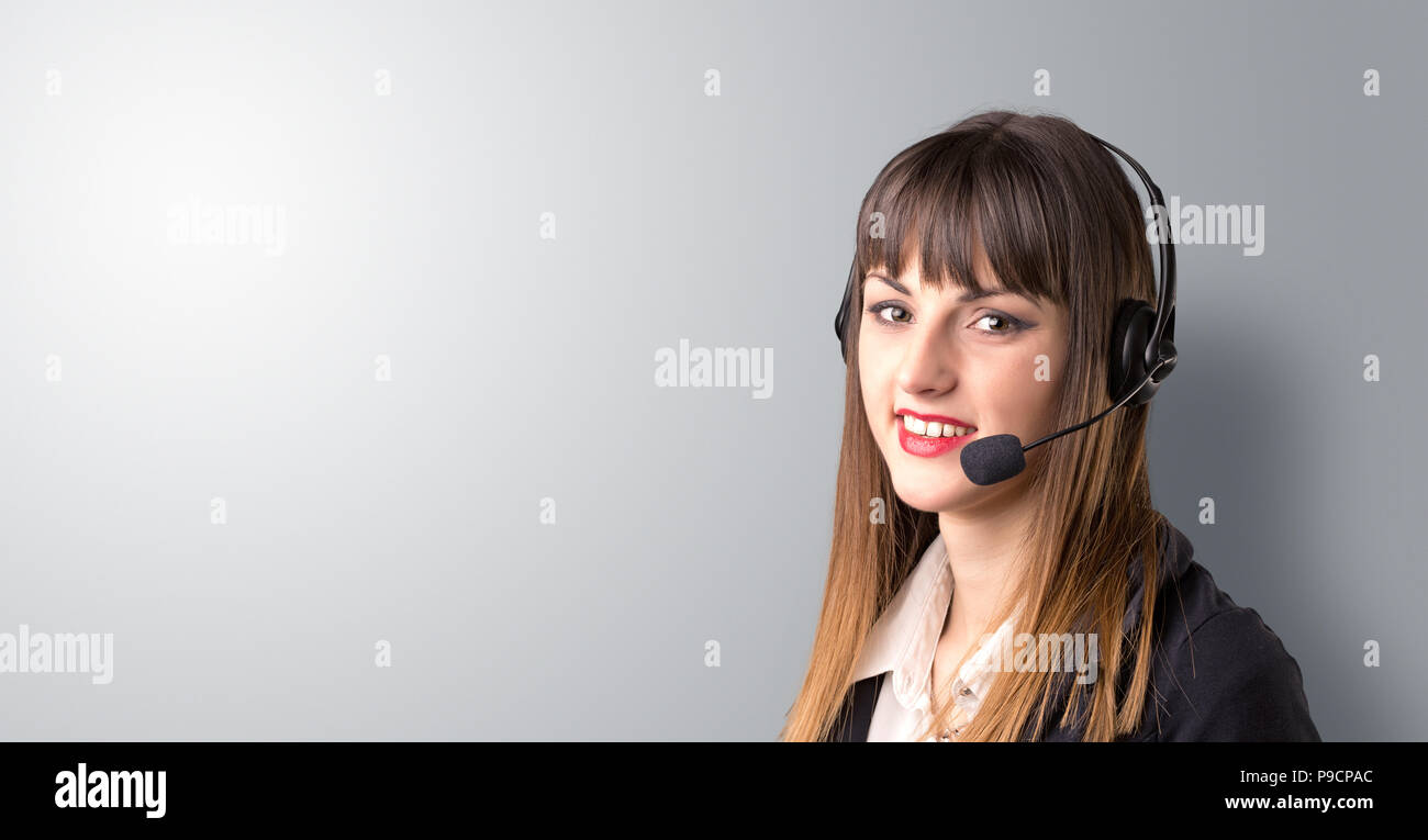 Young female telemarketer on a white background Stock Photo - Alamy