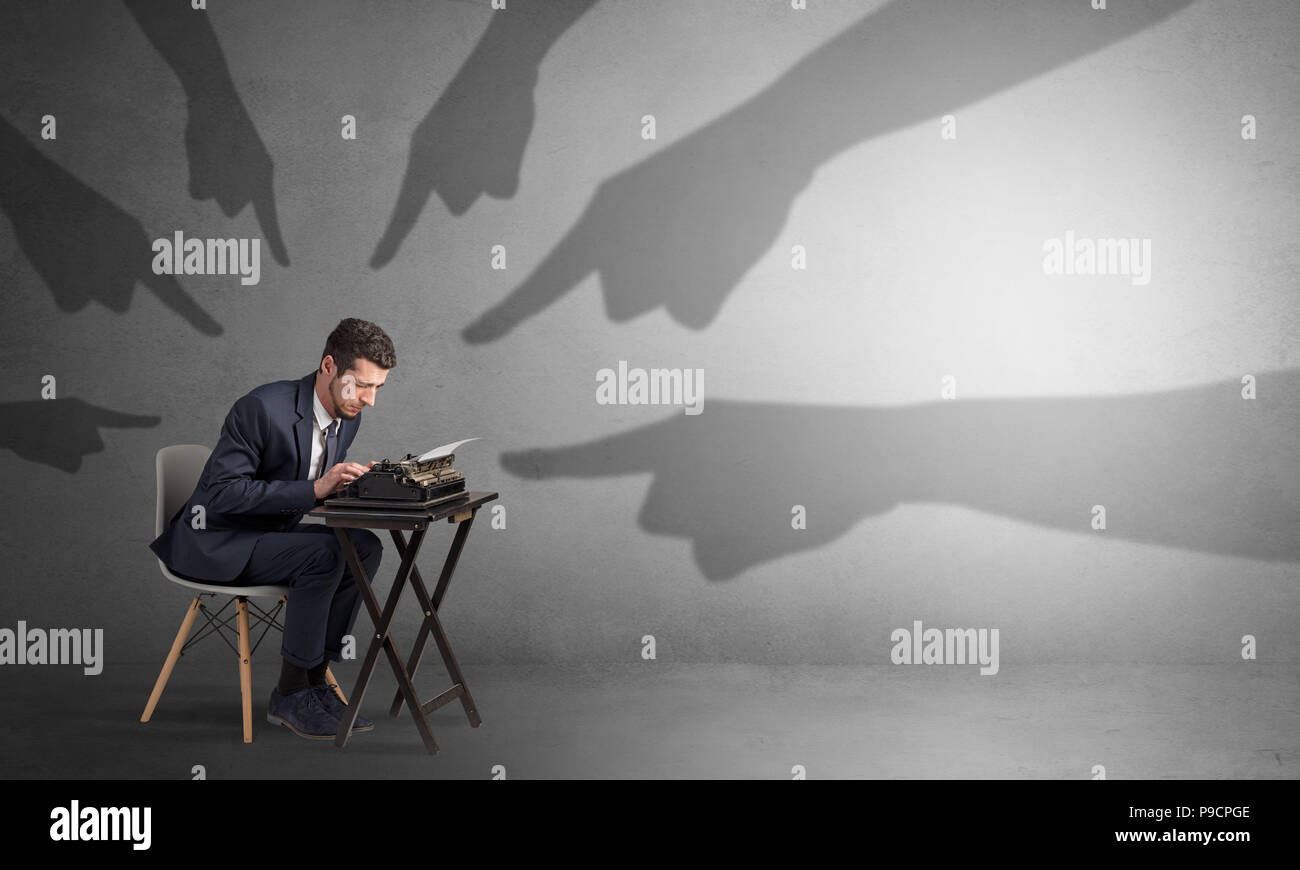 Shadow hand pointing at a small afraid worker Stock Photo - Alamy
