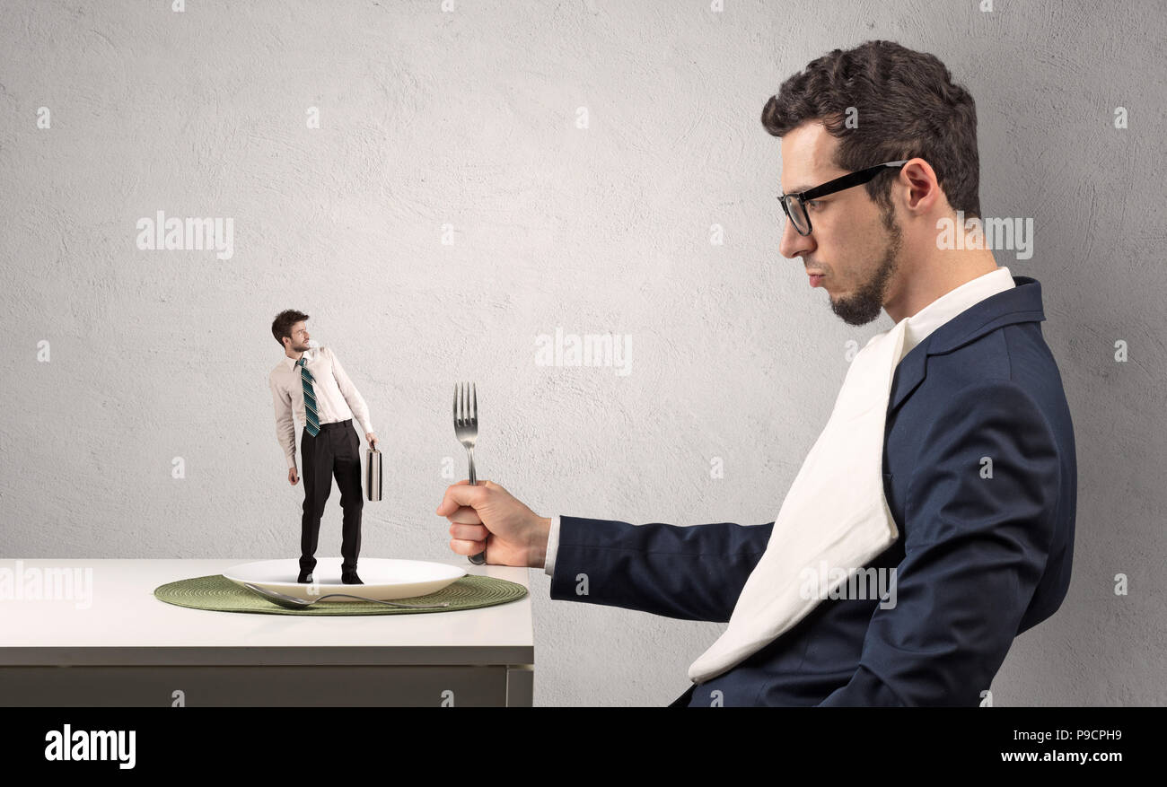 Tiny scared weak businessman almost devoured by great power Stock Photo ...