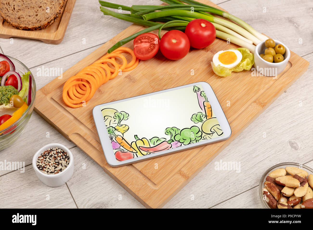 Healthy food composition with tablet Stock Photo - Alamy