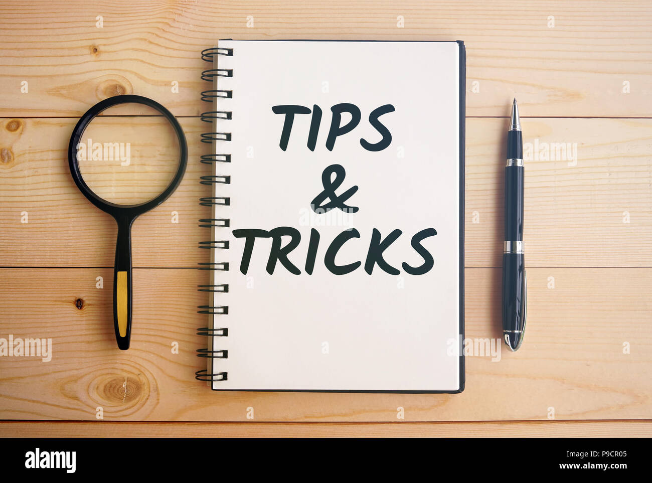 Tips and tricks text on notepad with pen and magnifying glass Stock ...